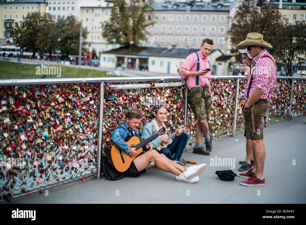Two young man play on guitar on the bridge in the Salzburg, Austria ...