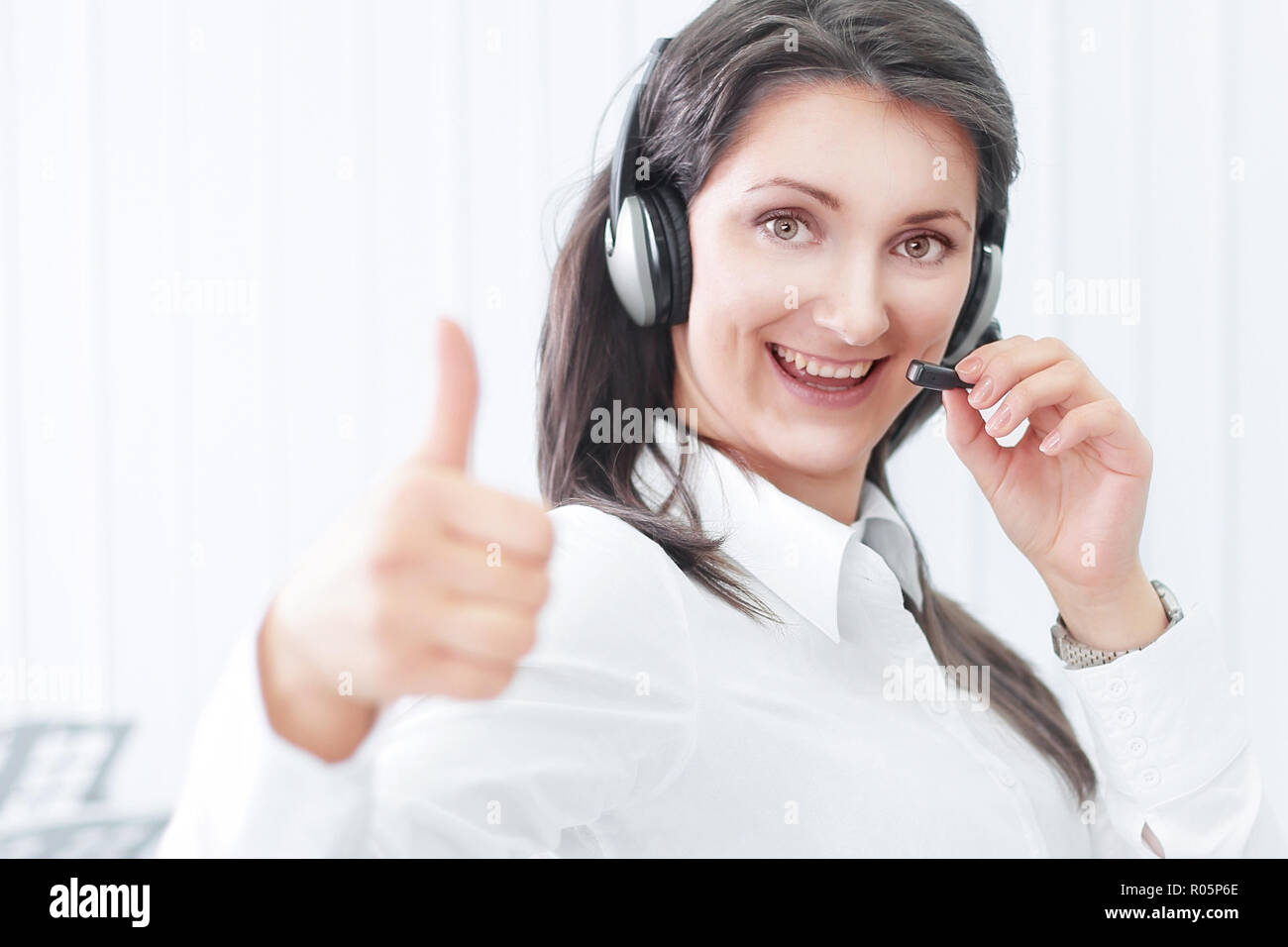 young employee call center showing thumb up Stock Photo - Alamy