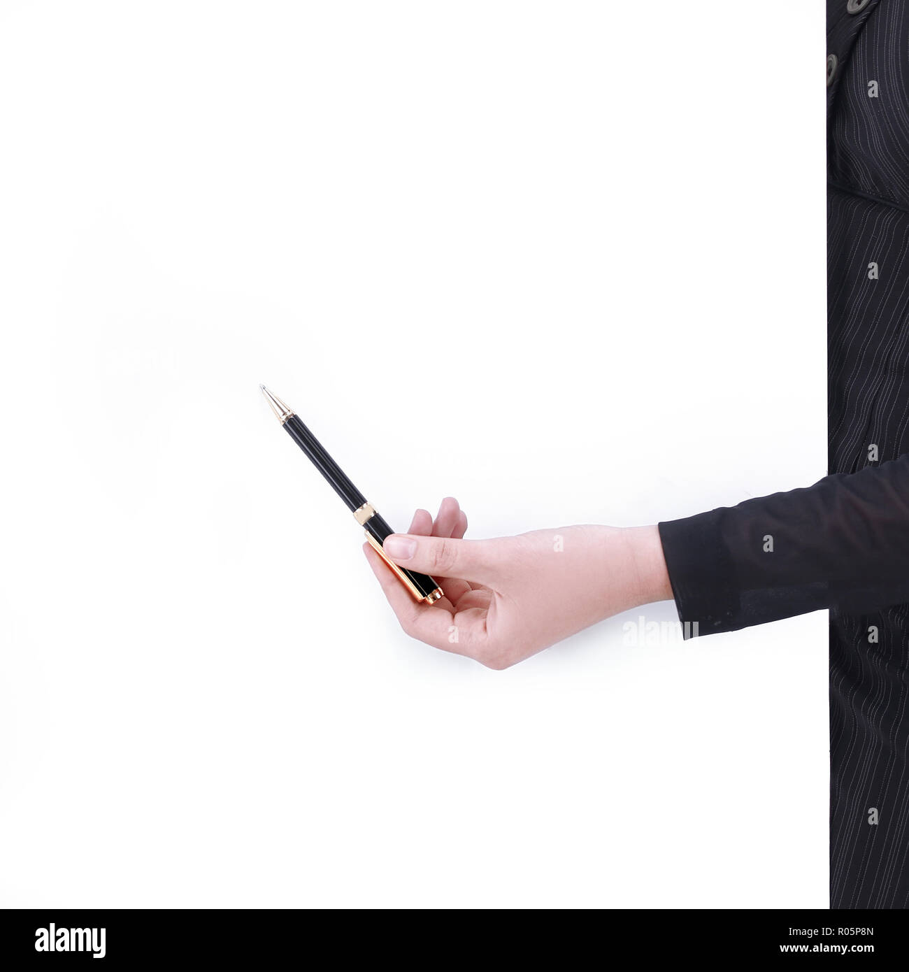 hand of business woman pointing with pen at a point on the blank screen ...