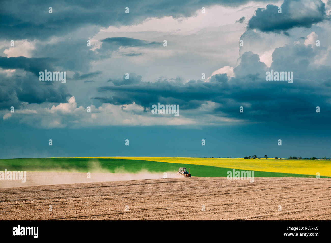 Tractor Plowing Field In Spring Season. Beginning Of Agricultural ...
