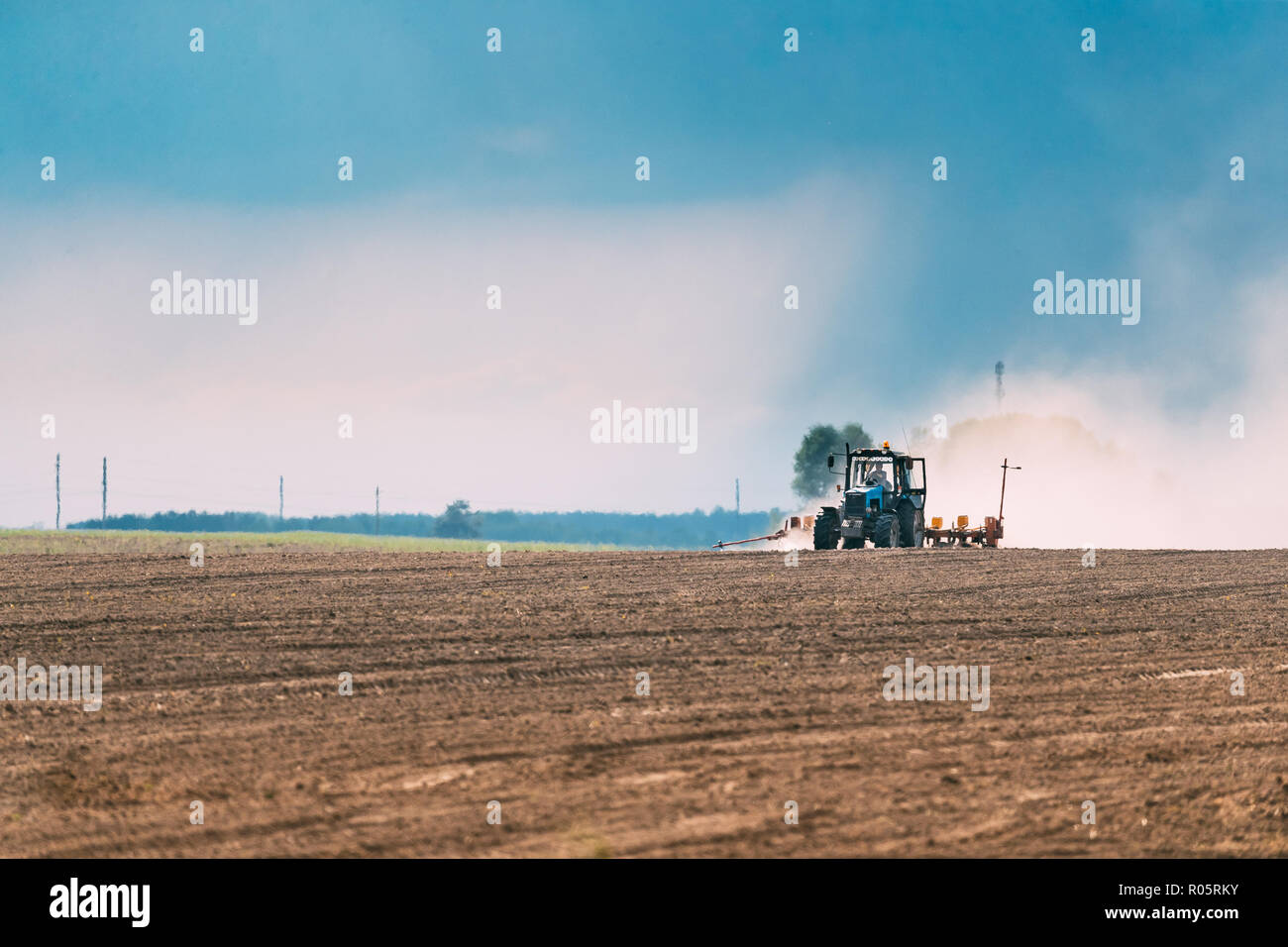 Tractor Plowing Field In Spring Season. Beginning Of Agricultural ...