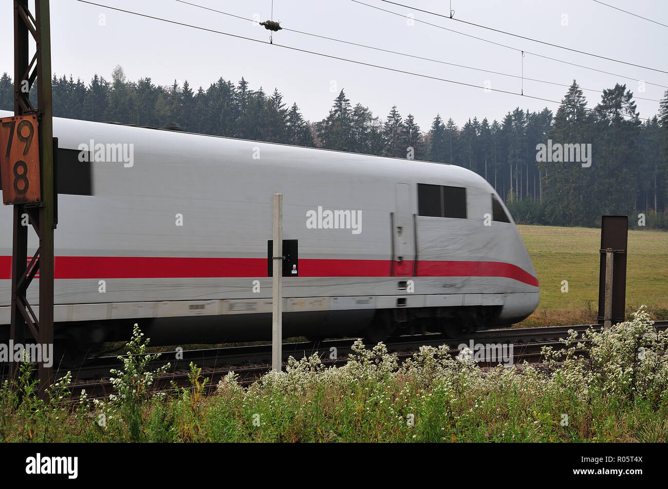 kilometric mileposting at railway tracks in countryside, white train ...