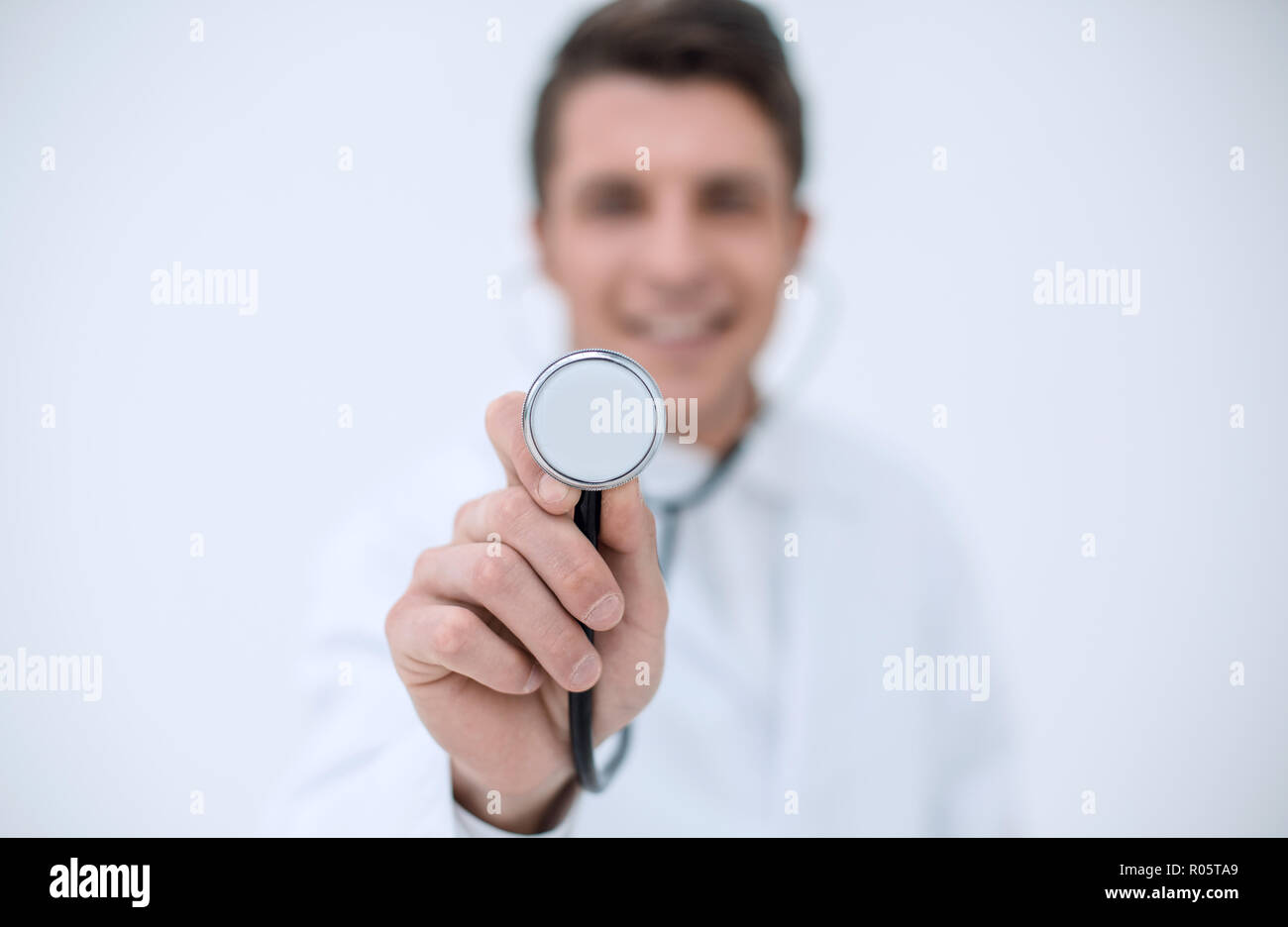 smiling doctor showing stethoscope.the concept of diagnosis Stock Photo ...