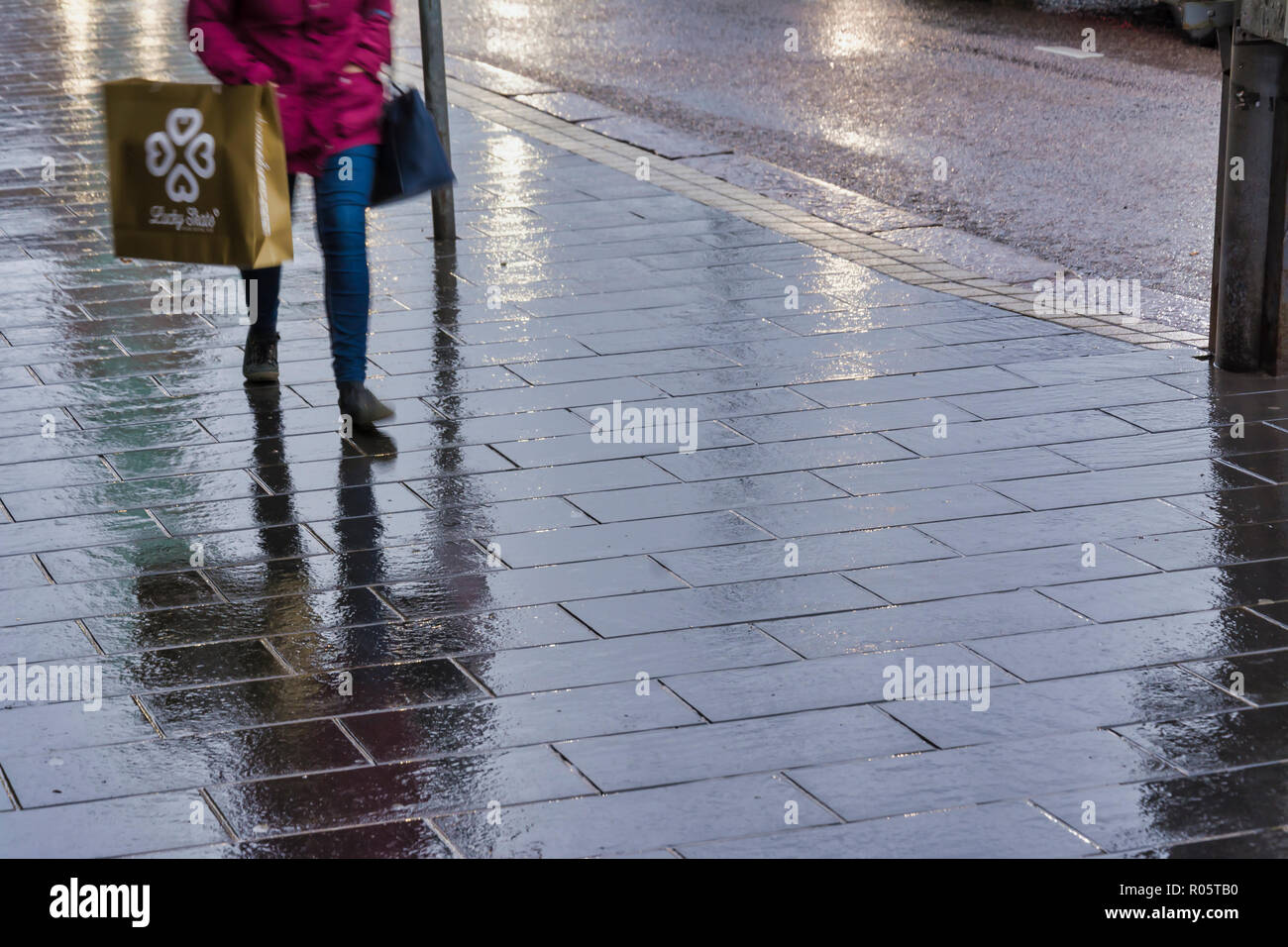 Woman walking the street in pouring rain in Helsinki Finland Stock ...