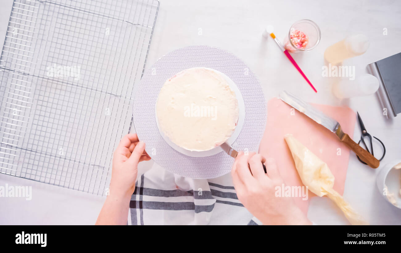 Step by step. Flat lay. Icing tall birthday cake with white buttercream ...