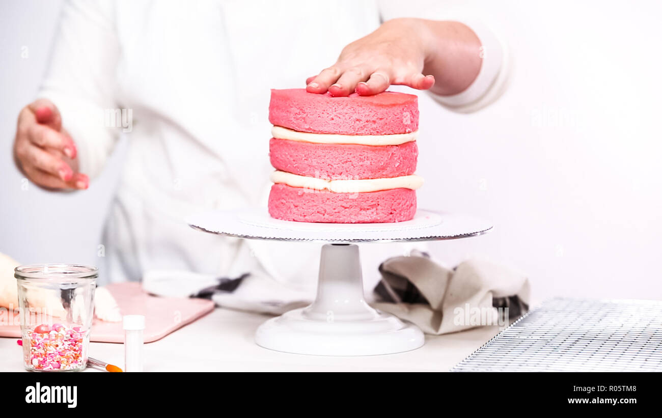 Step by step. Stacking layers together of pink birthday cake Stock ...
