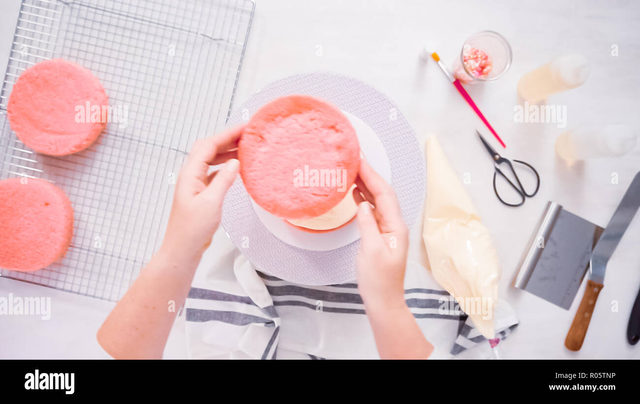 Step by step. Flat lay. Stacking layers together of pink birthday cake ...