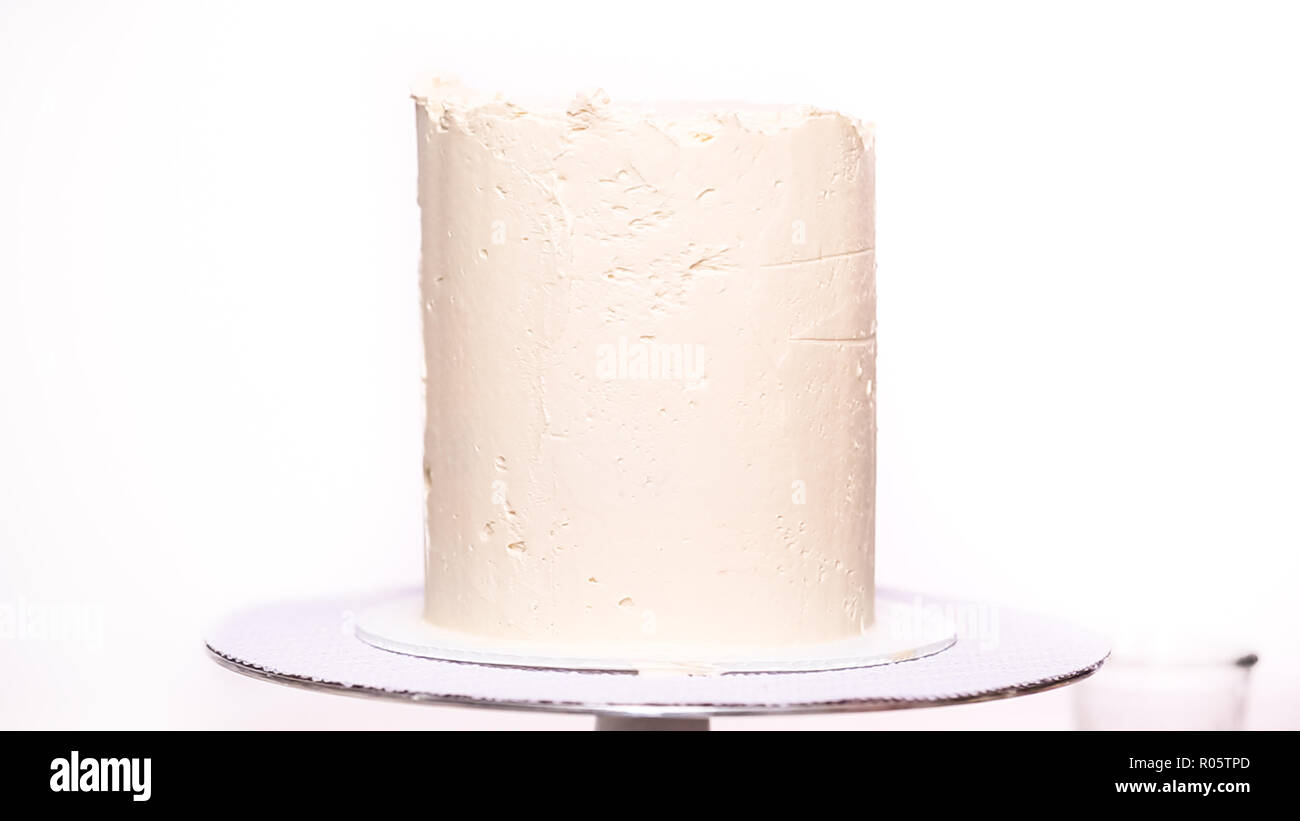 Step by step. Icing tall birthday cake with white buttercream icing ...