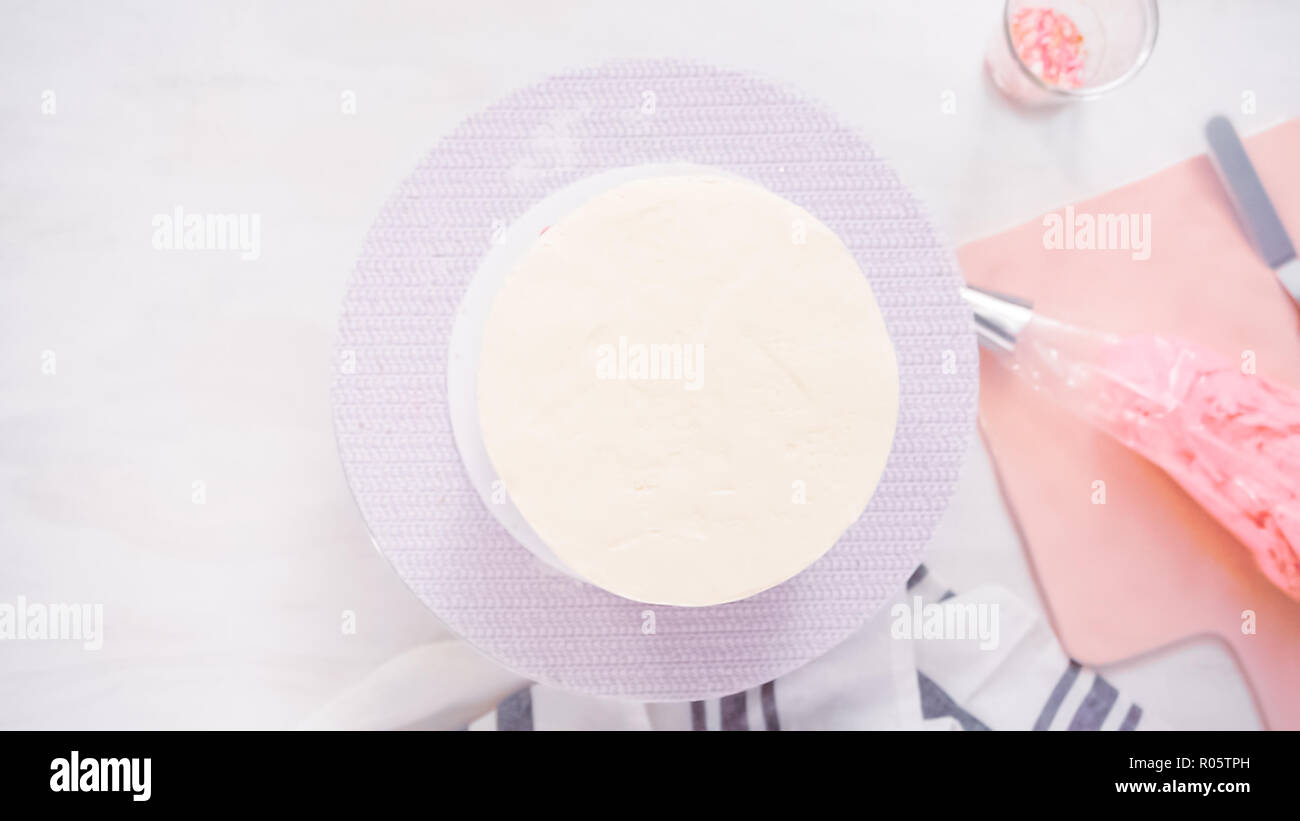 Step by step. Flat lay. Icing tall birthday cake with white buttercream ...