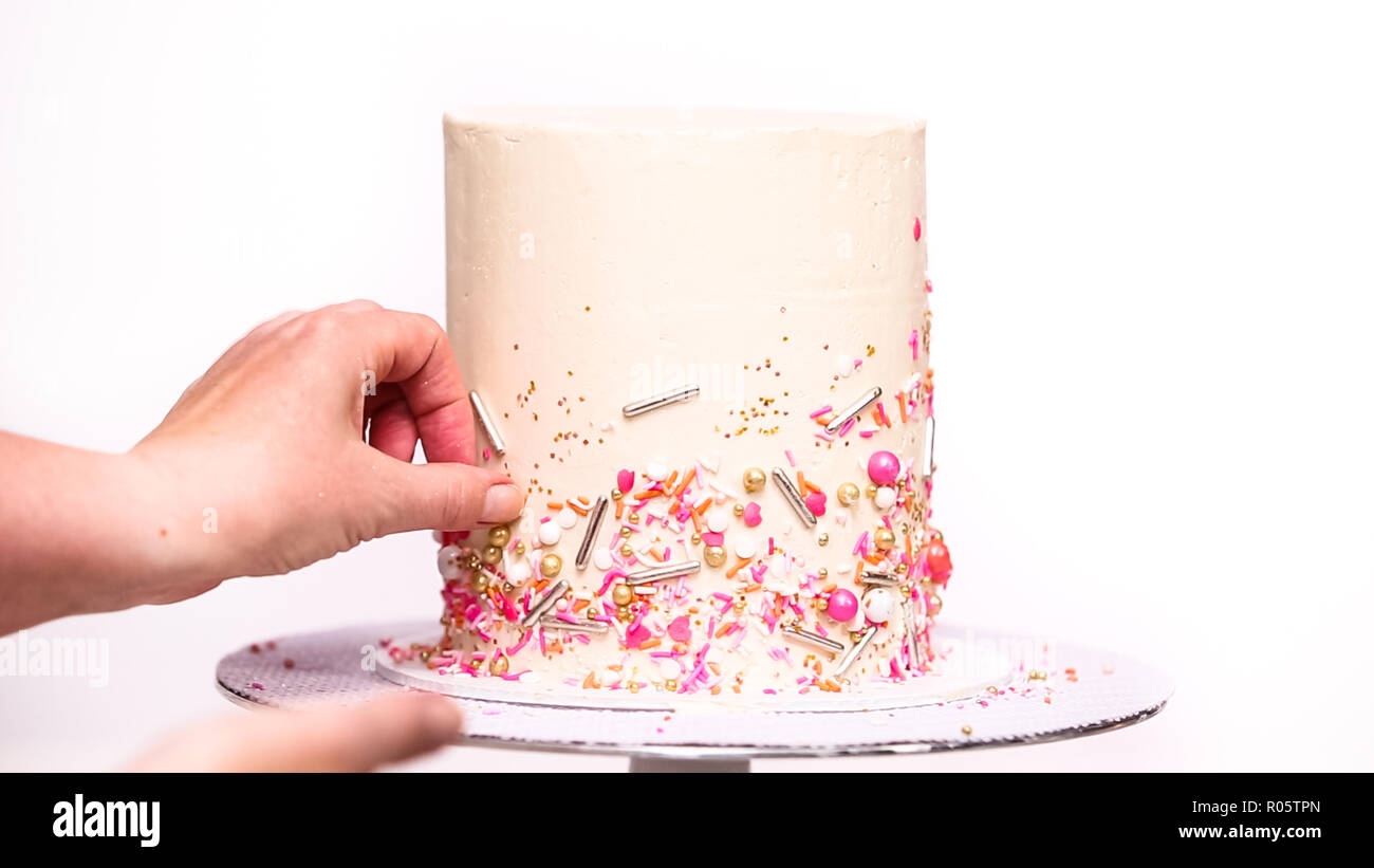 Step by step. Decorating tall birthday cake with a pink sprinkles Stock ...