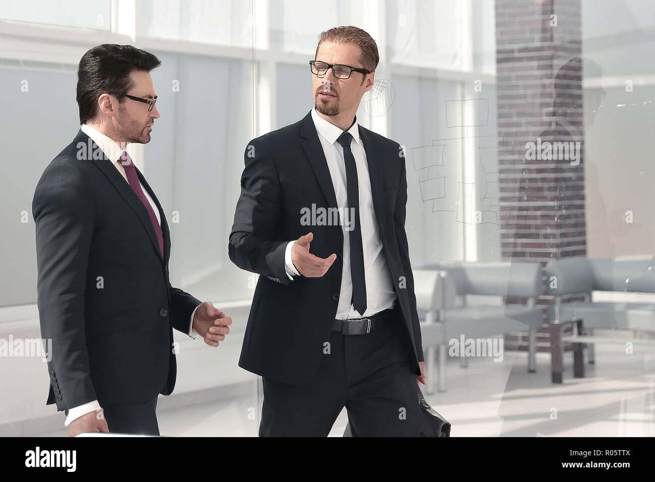 Businessman standing inside building talking hi-res stock photography ...