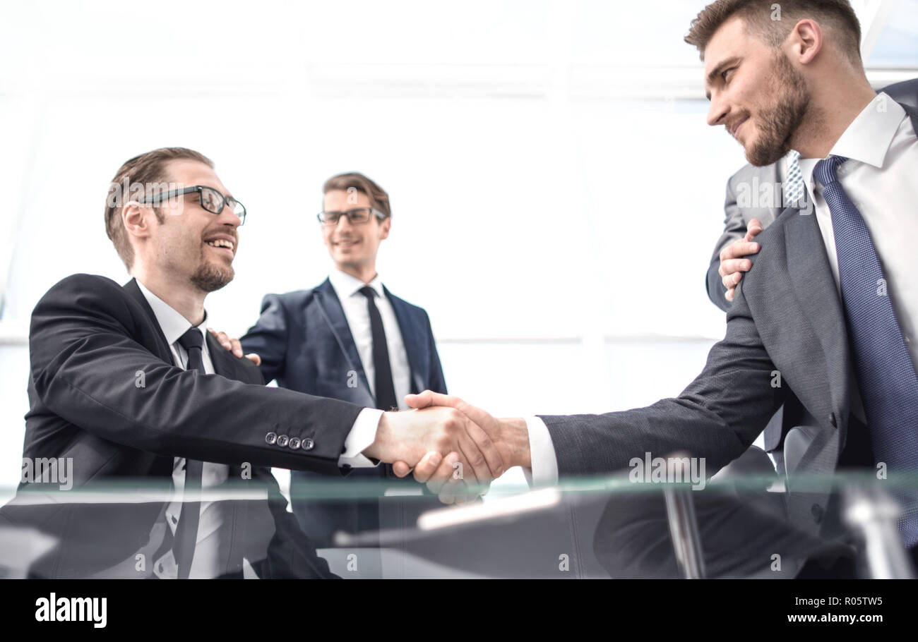 confident handshake business partners at the Desk.concept of ...