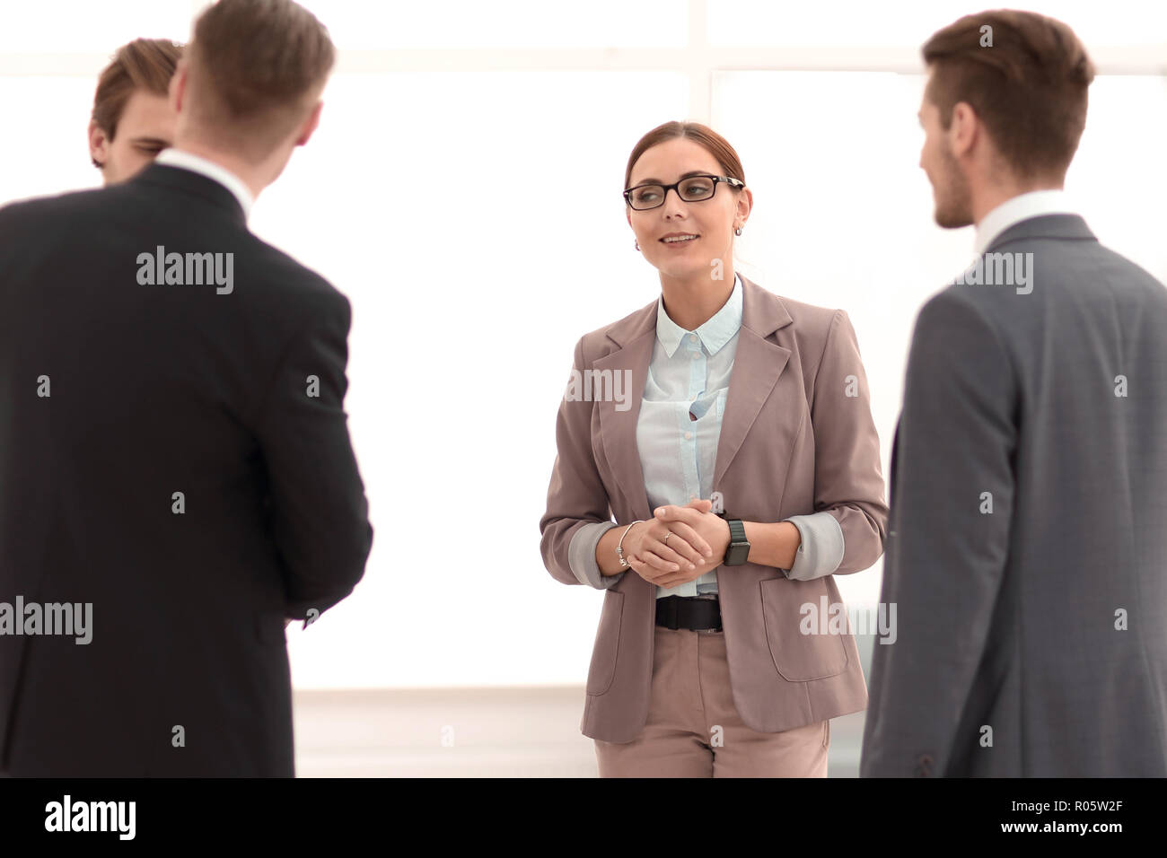 group of employees talking while standing in the office. the concept of ...