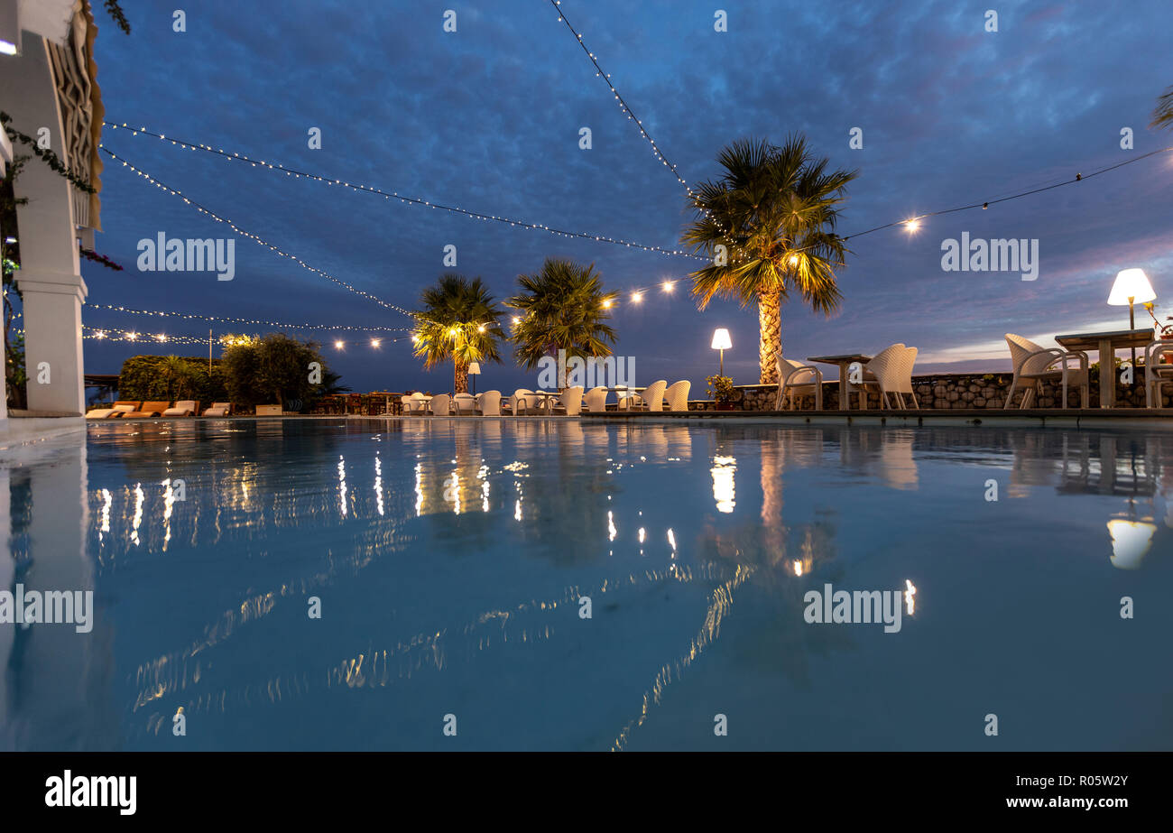 Romantic restaurant by the pool at night. Reflection in water Stock ...