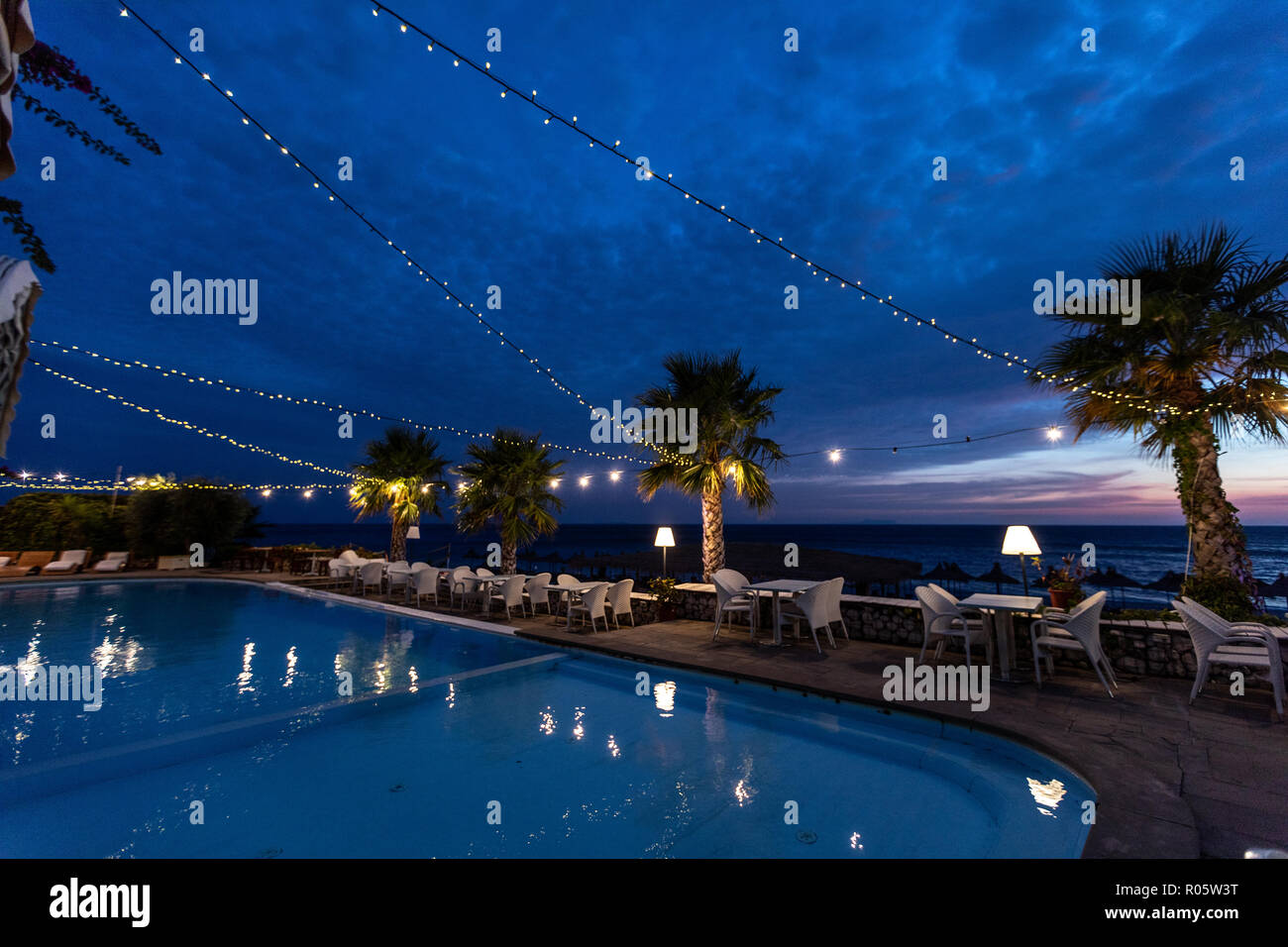 Romantic restaurant by the pool at night. Reflection in water Stock ...
