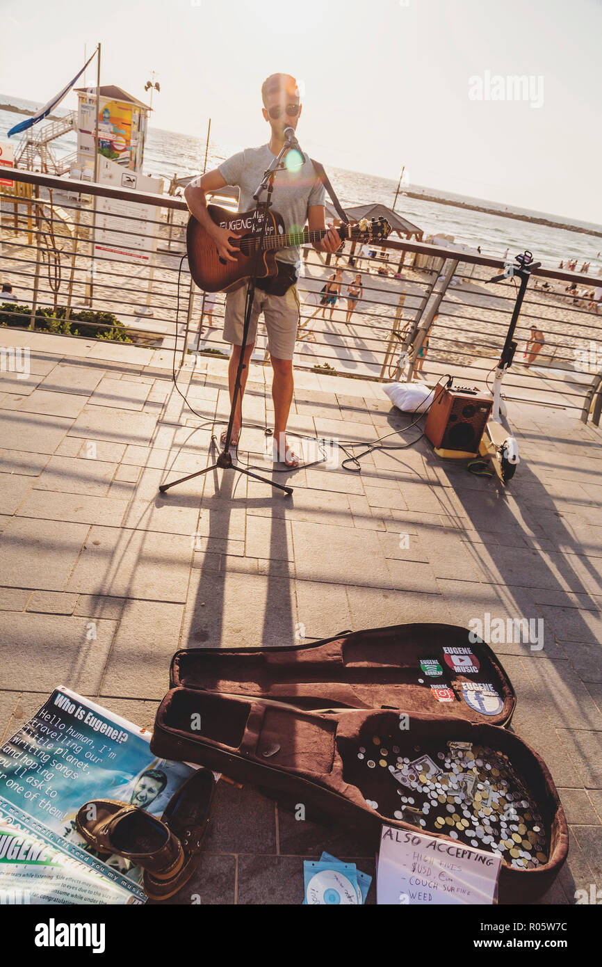 Tel Aviv-Yafo, Israel - June 6, 2018: Street musician playing a guitar ...