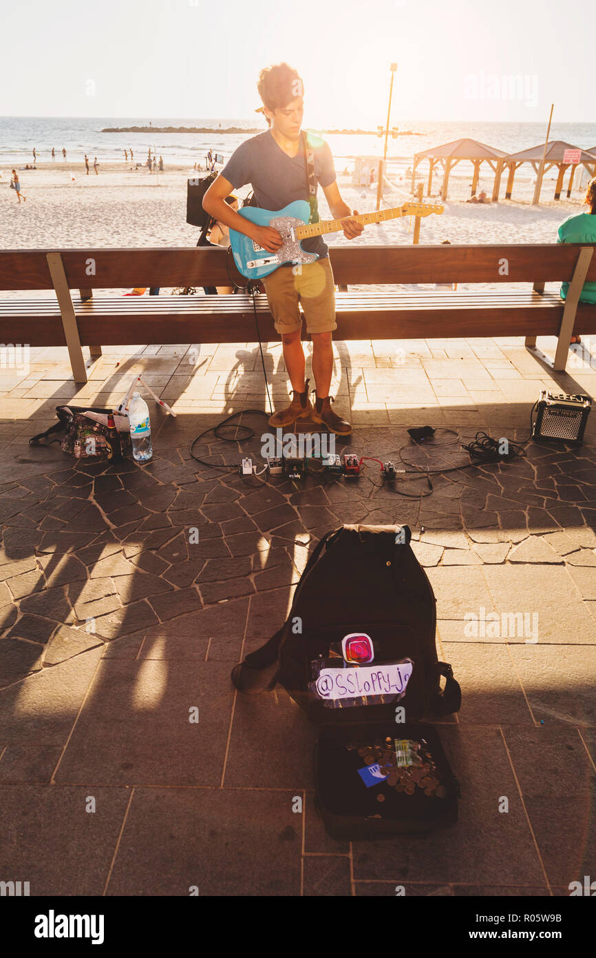 Tel Aviv-Yafo, Israel - June 6, 2018: Street musician playing a guitar ...