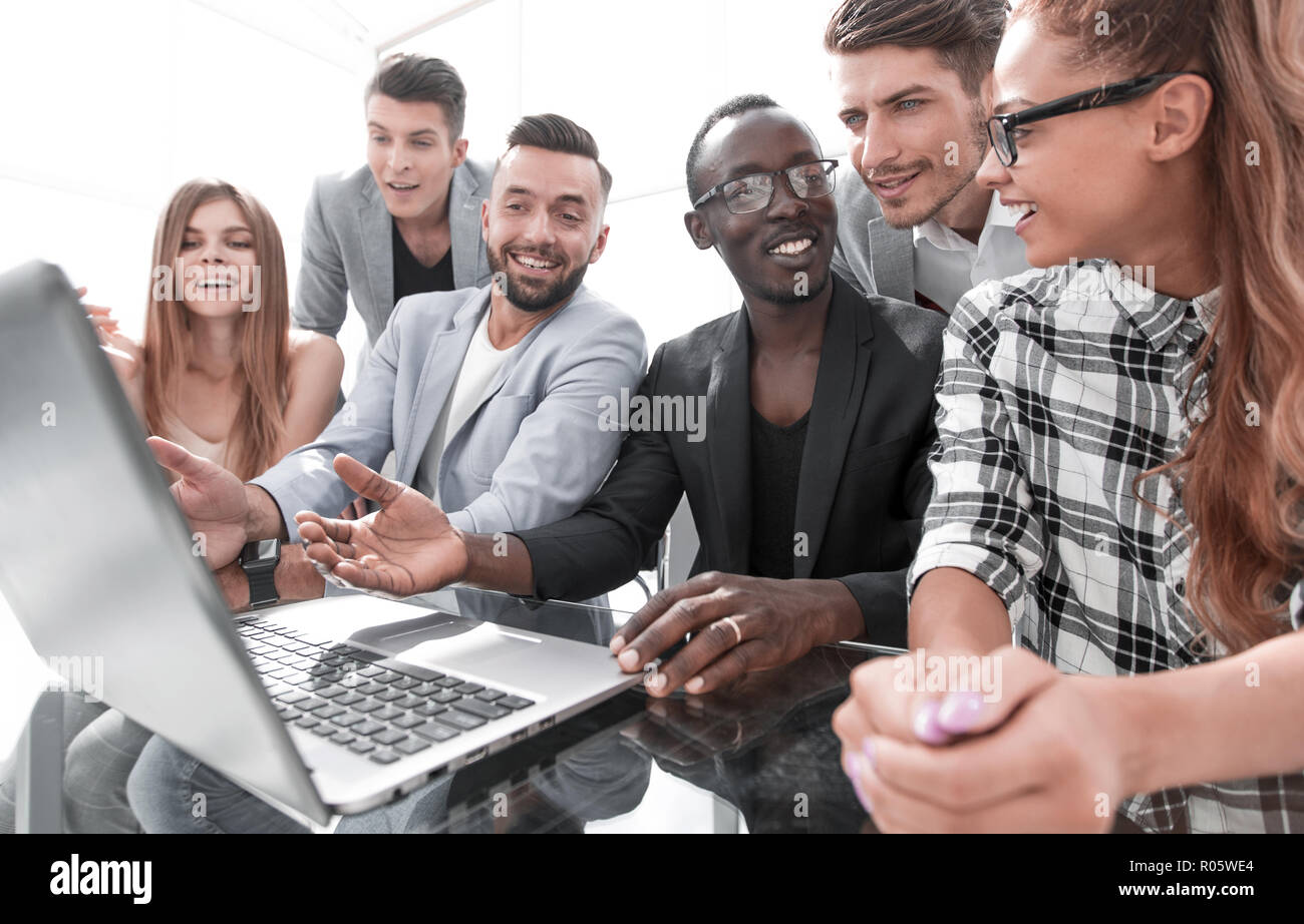 Group of young confident business people analyzing data using computer ...