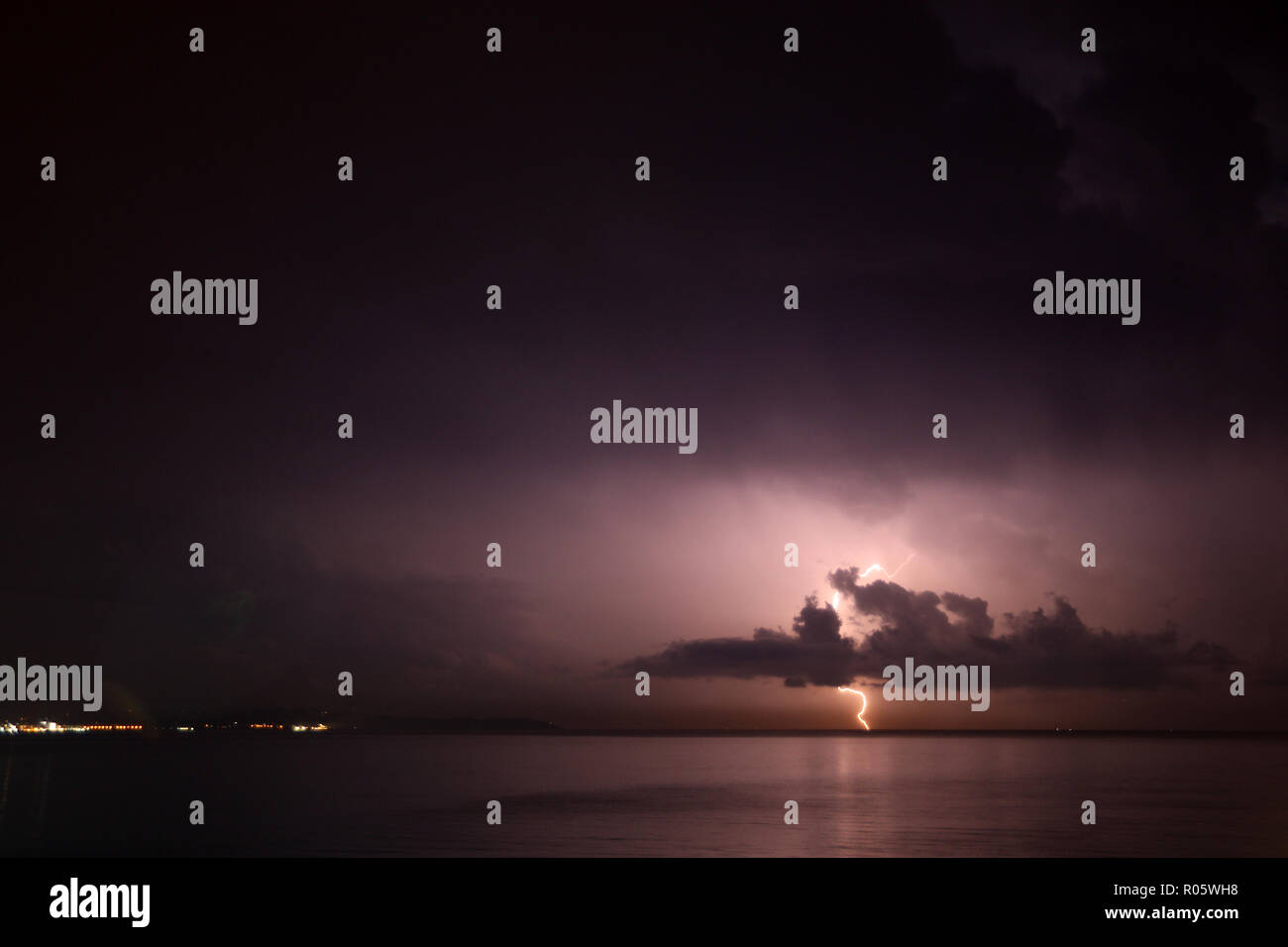 Lightning above the sea. Sea at night Stock Photo - Alamy