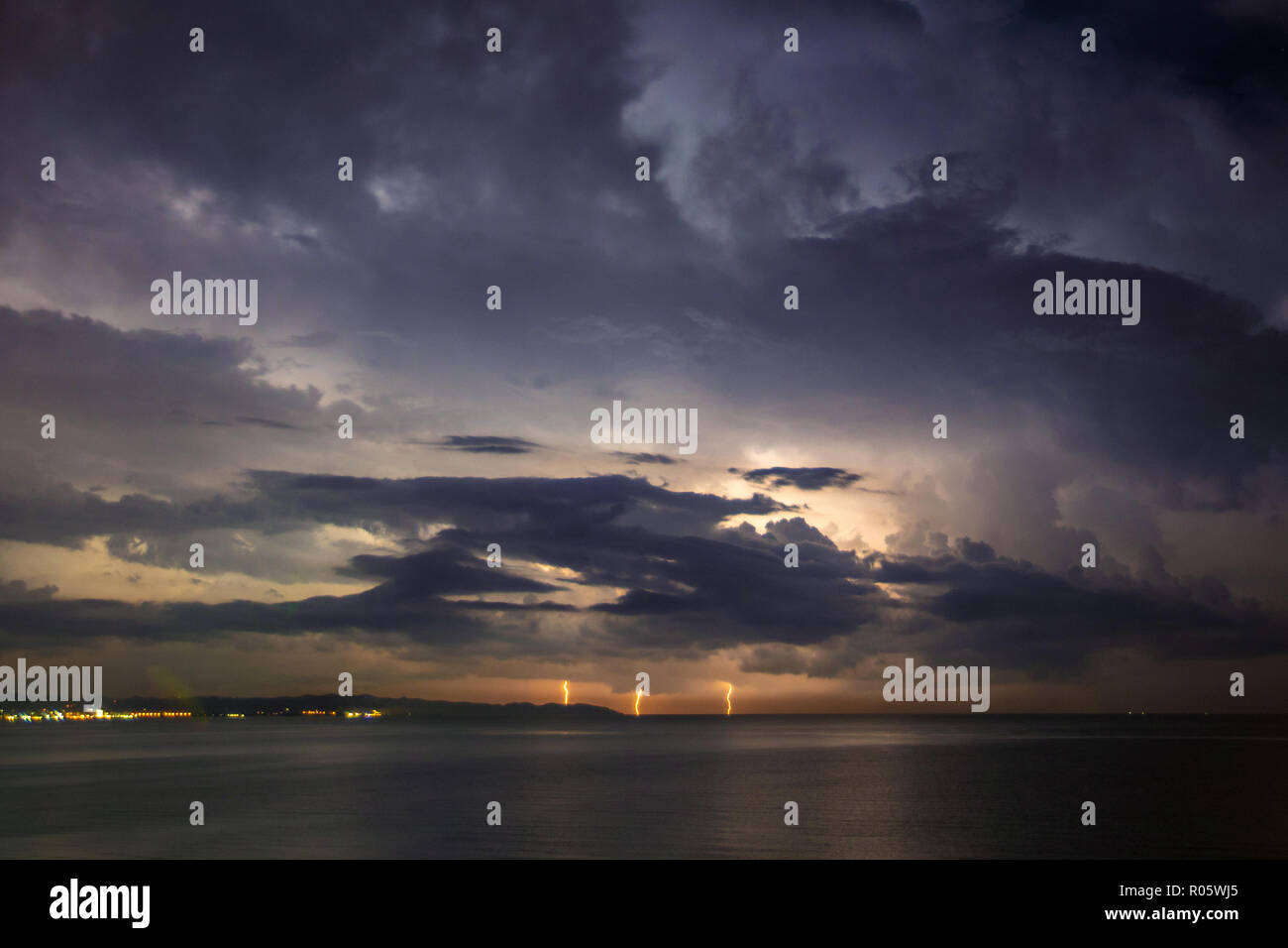 Lightning above the sea. Sea at night Stock Photo - Alamy