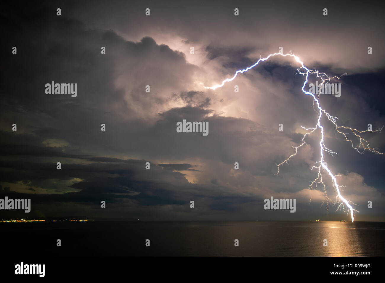 Lightning above the sea. Sea at night Stock Photo - Alamy