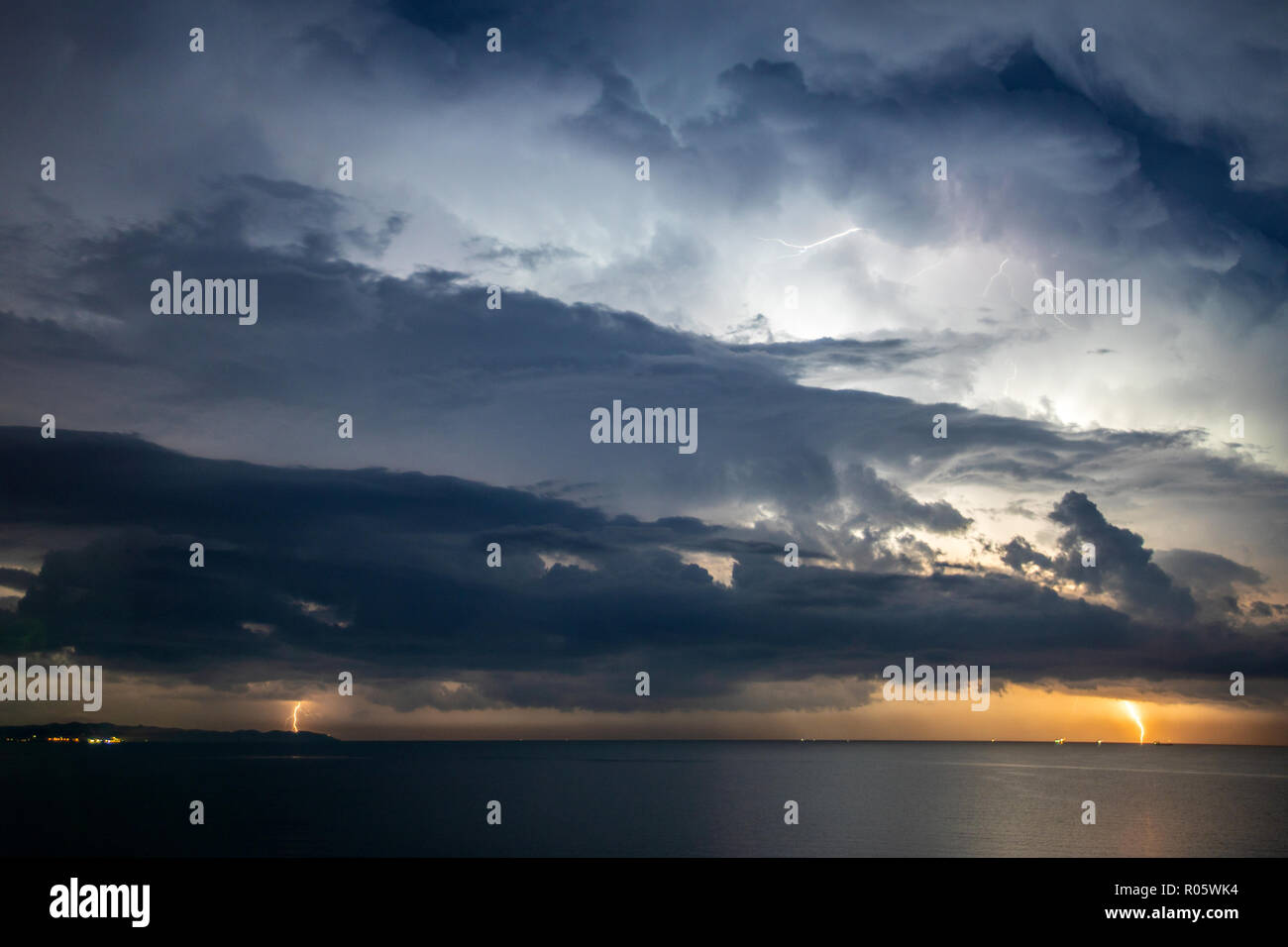 Lightning above the sea. Sea at night Stock Photo - Alamy
