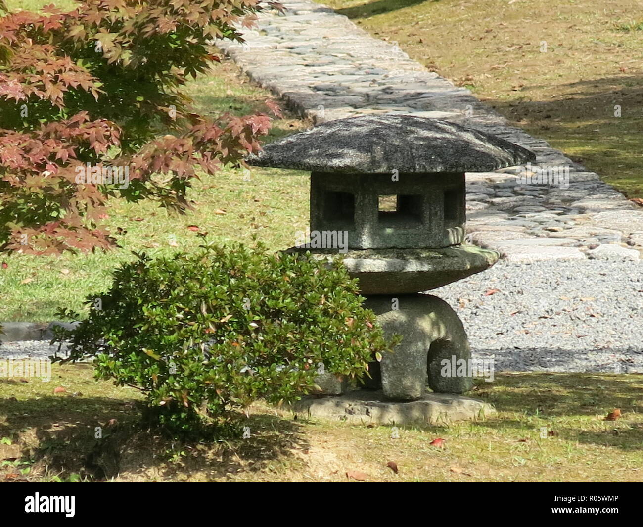A traditional Japanese stone lantern in a garden in Kyoto, Japan Stock ...