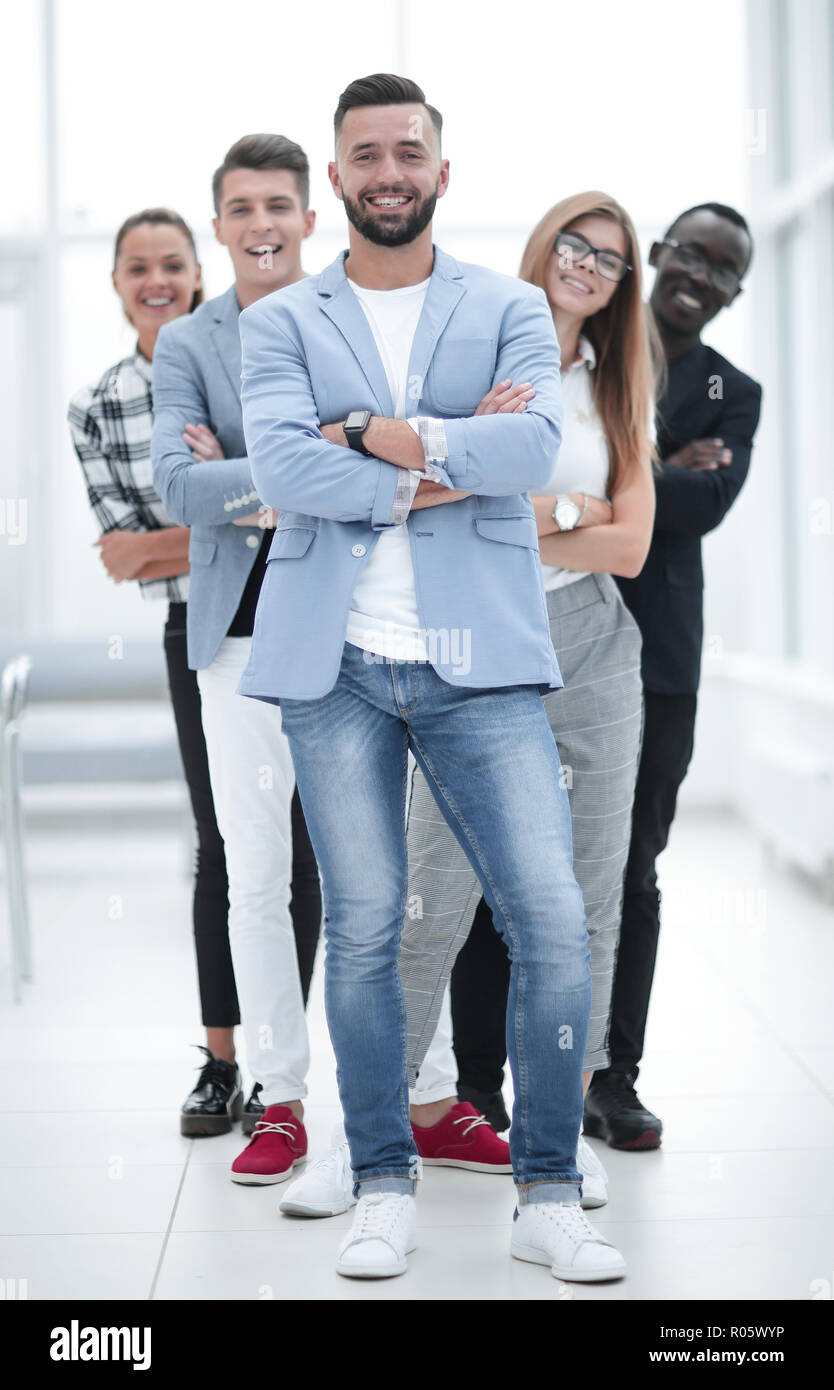 a young man of European appearance stands first, behind him his team ...
