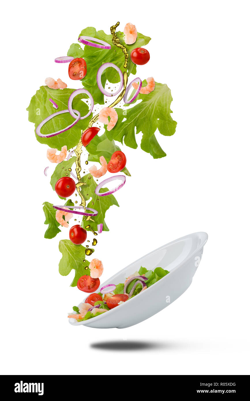 Falling plate with fresh salad Stock Photo - Alamy