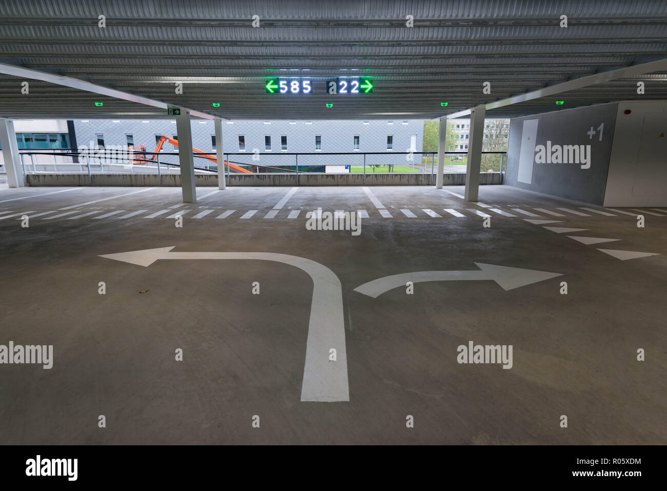 Arrows on the ground of a parking garage indicating which side to turn ...
