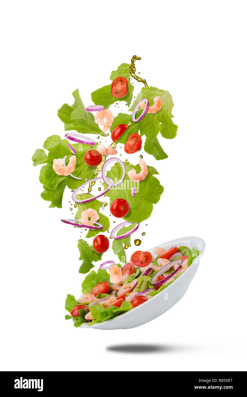 Tasty salad with flying pieces Stock Photo - Alamy