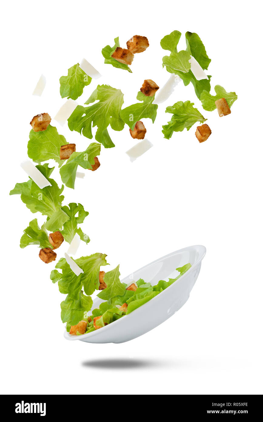 Flying salad over white background Stock Photo - Alamy