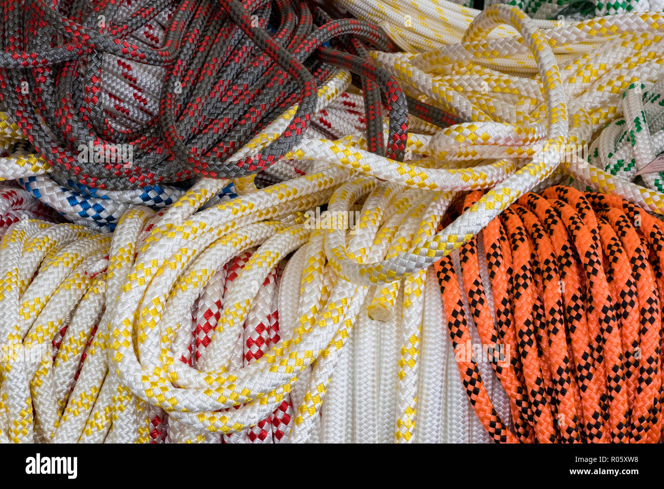 a selection of multi-coloured lengths of yachting and sailing ropes for ...
