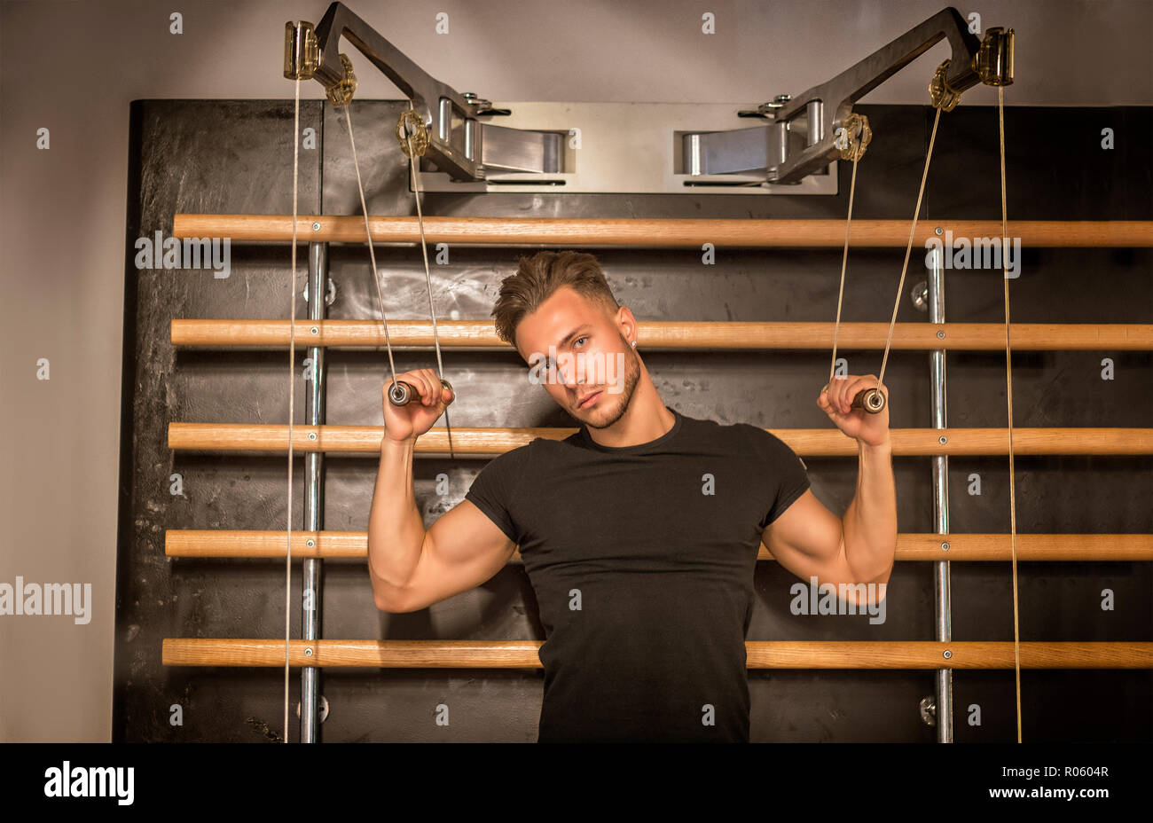 Muscular young man, training pecs on gym bench Stock Photo - Alamy