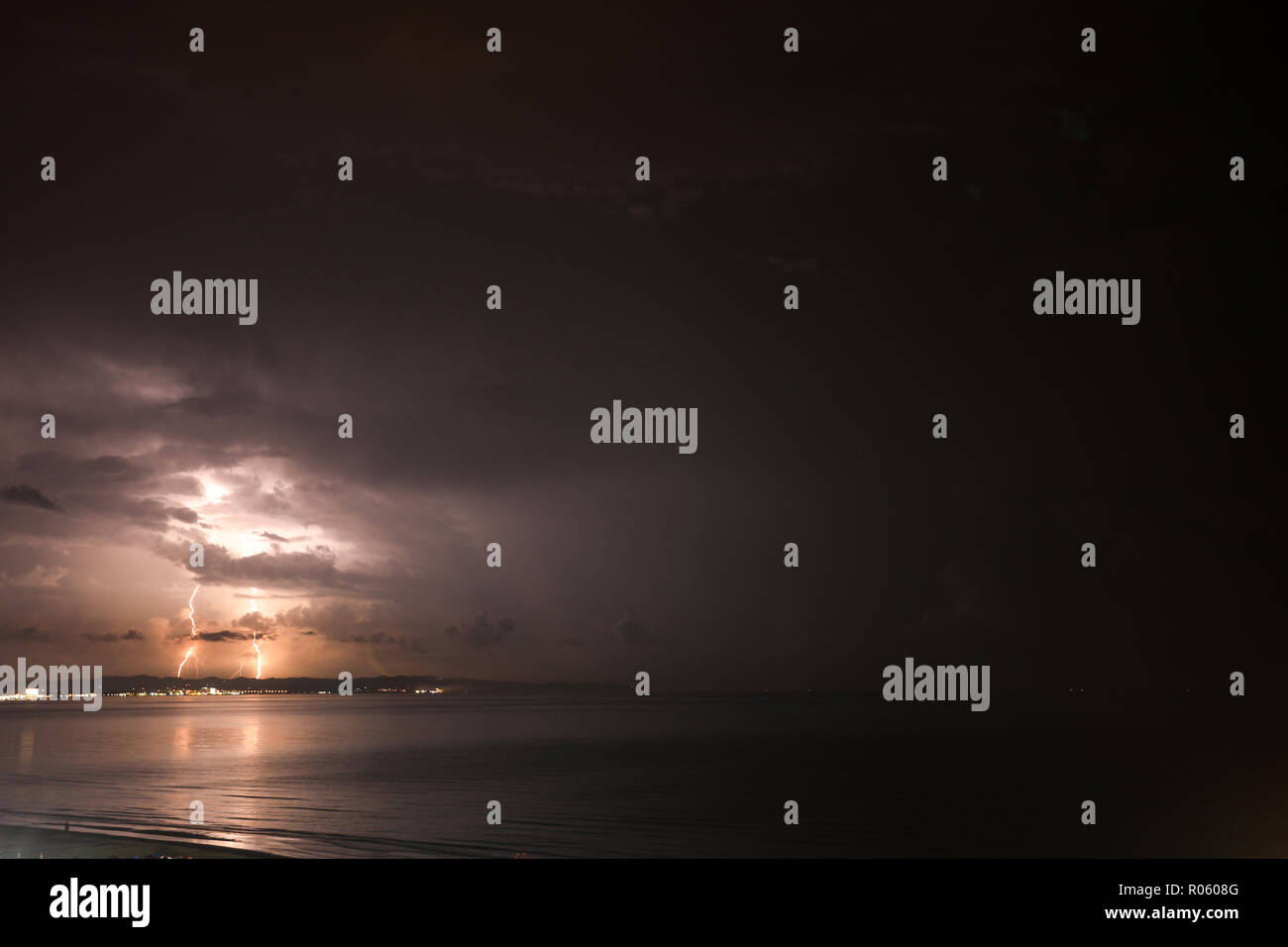 Thunderstorm over the sea, lightning beats the sea Stock Photo - Alamy