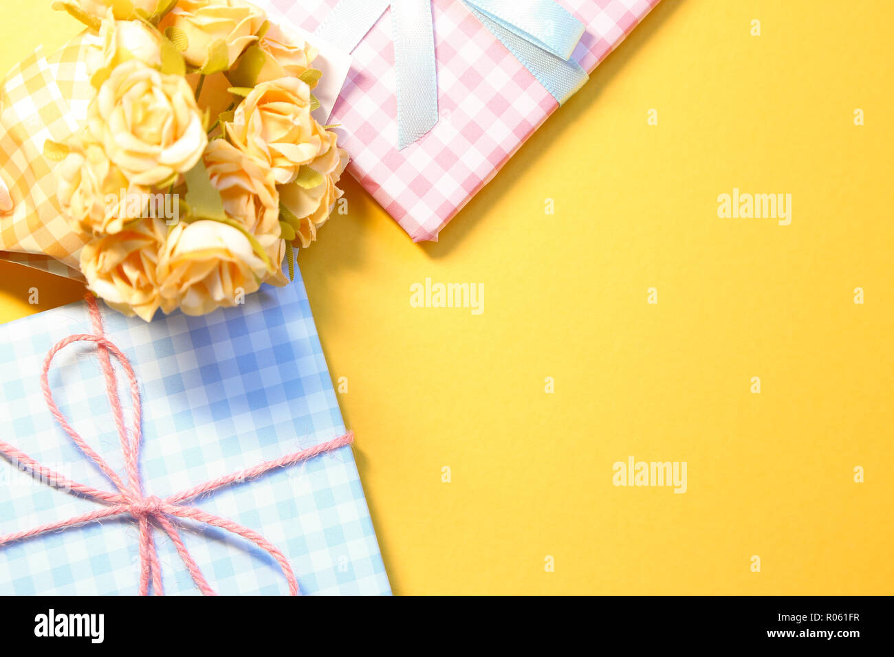 Check pattern colorful gift boxes with flower bouquet on yellow ...