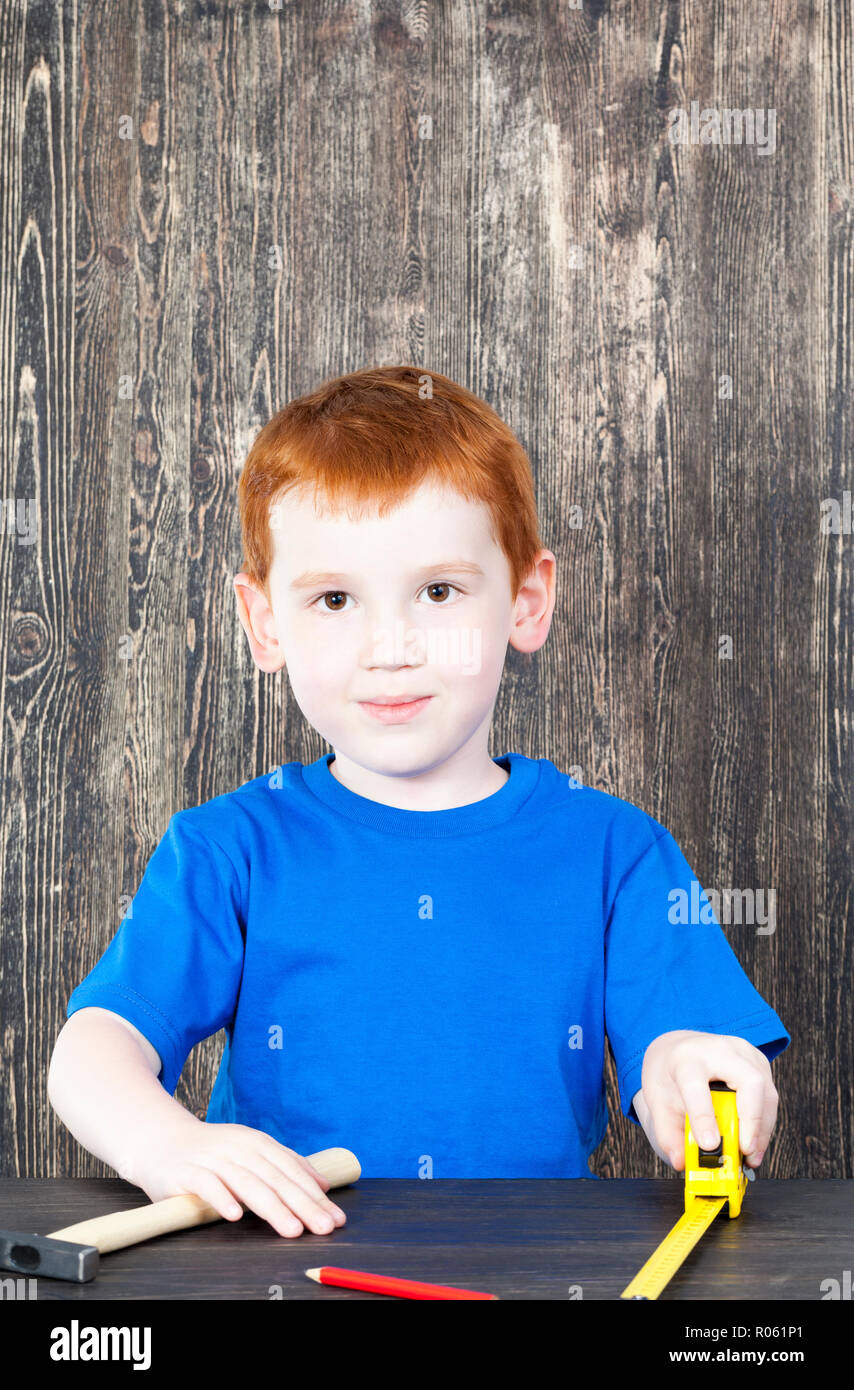 little boy with construction tools during construction and labor lesson ...