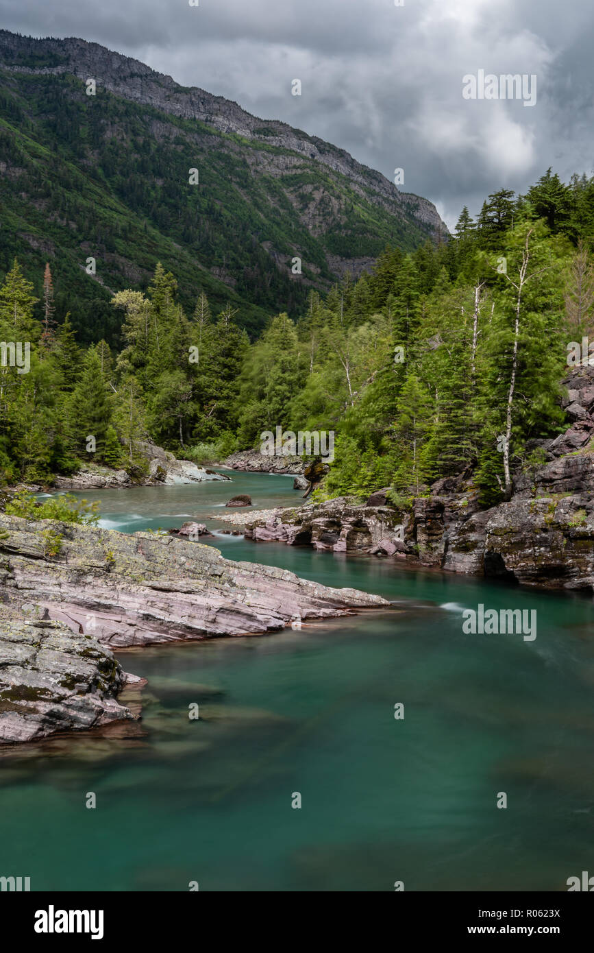 Clear Blue Water Curves Around Rocky Shore Stock Photo - Alamy
