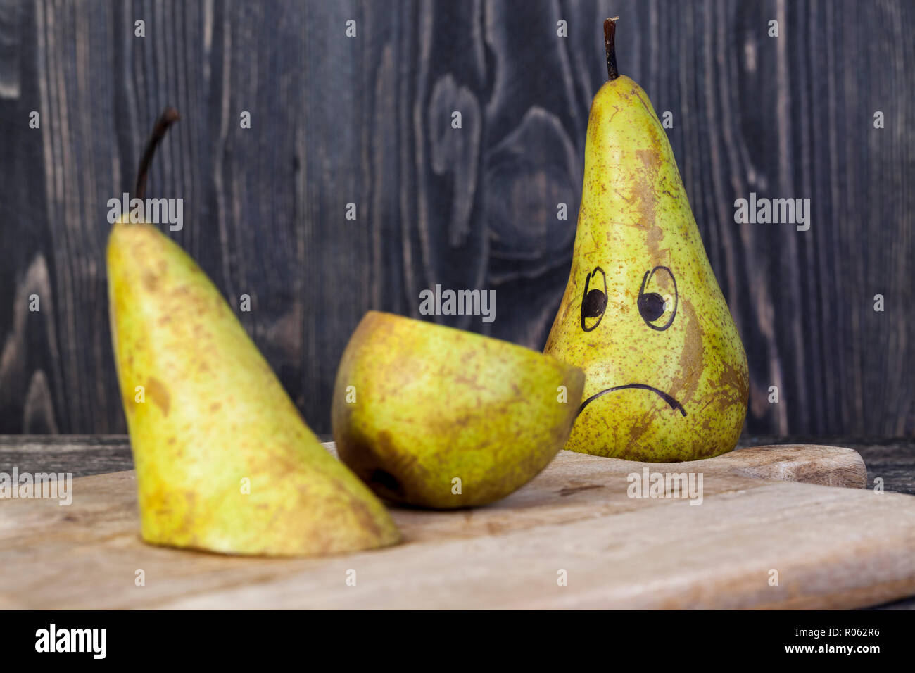 several sliced pears at the time of making dessert, one pear with sad ...
