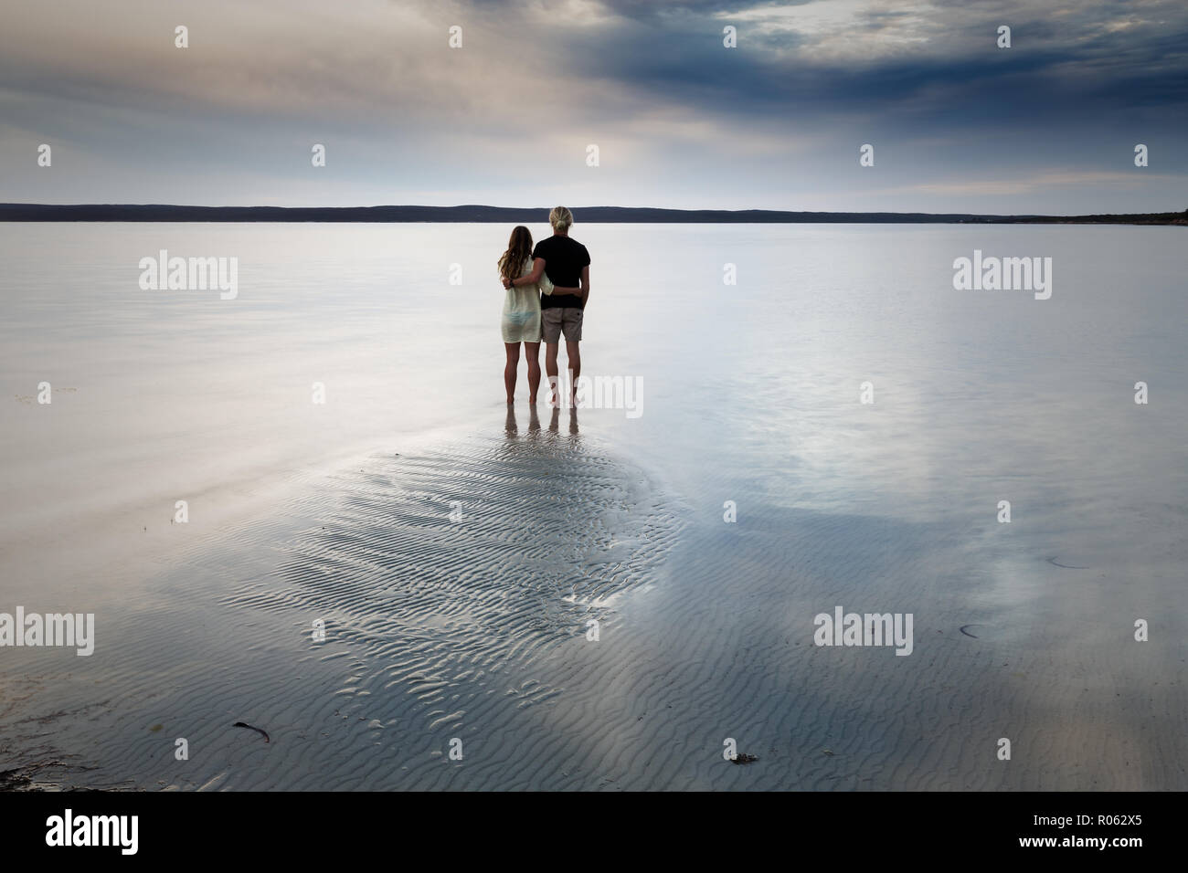 Stormy beach with a woman walking hi-res stock photography and images ...