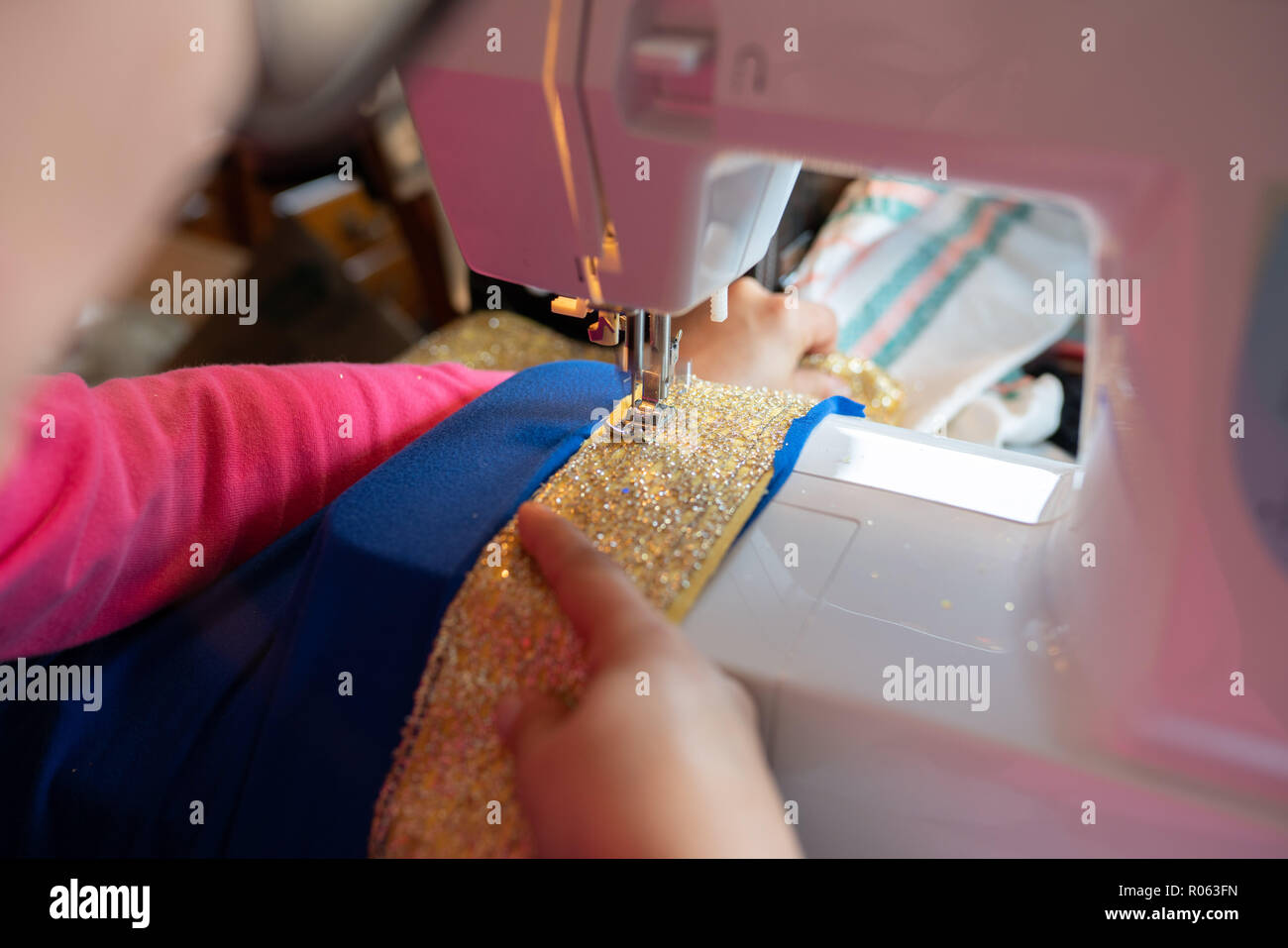 Female sewing a Halloween kid costume on the machine Stock Photo - Alamy