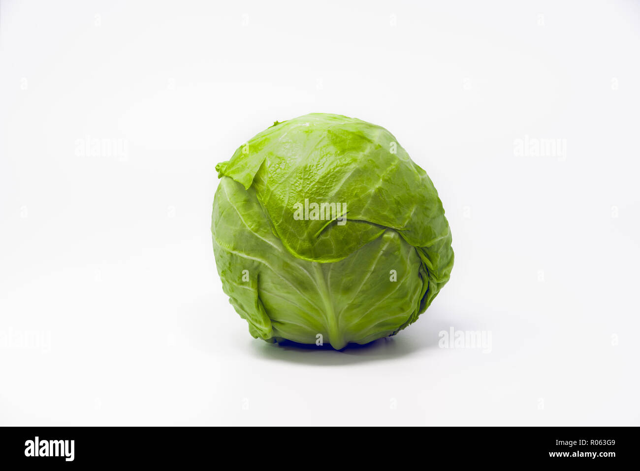 Green cabbage head isolated on white background Stock Photo - Alamy