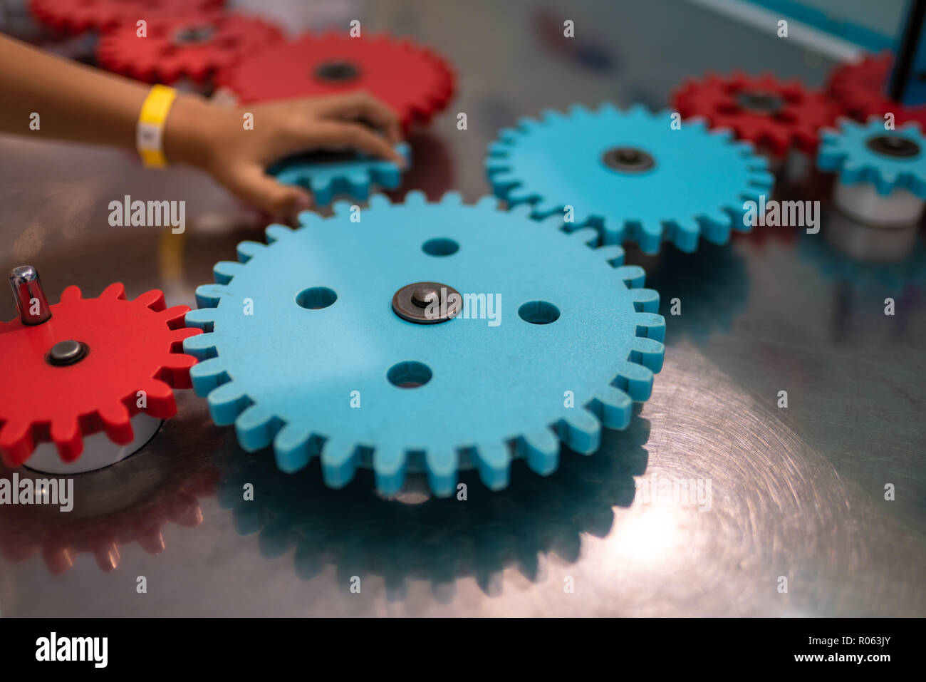 Child playing with colorful gears Stock Photo - Alamy
