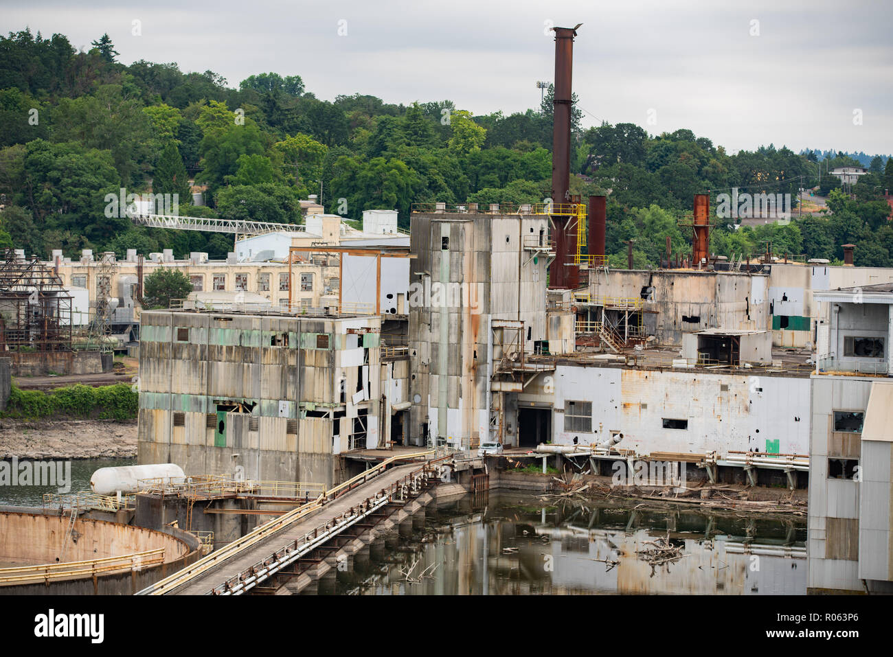 Abandoned old falling apart rusty factory on the Willamette river Stock ...