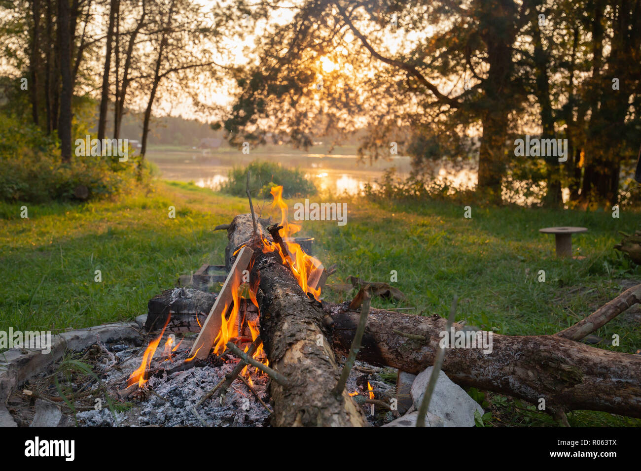 Lake side campfire with wood burning in a scenic setting during the ...