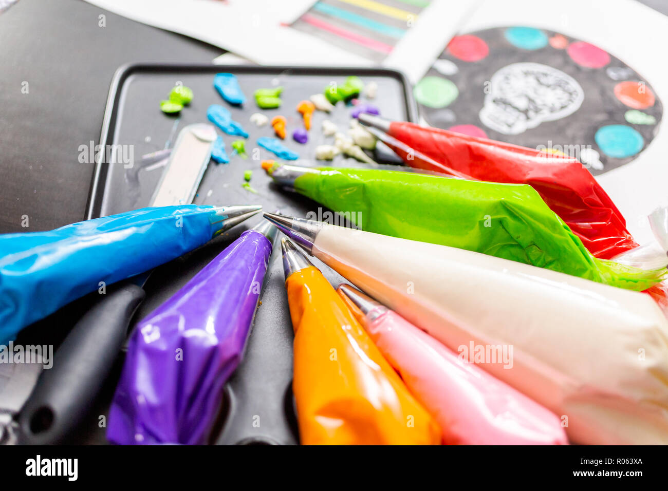 Flat lay. Gourmet Dia de los Muertos cake decorated with colorful ...