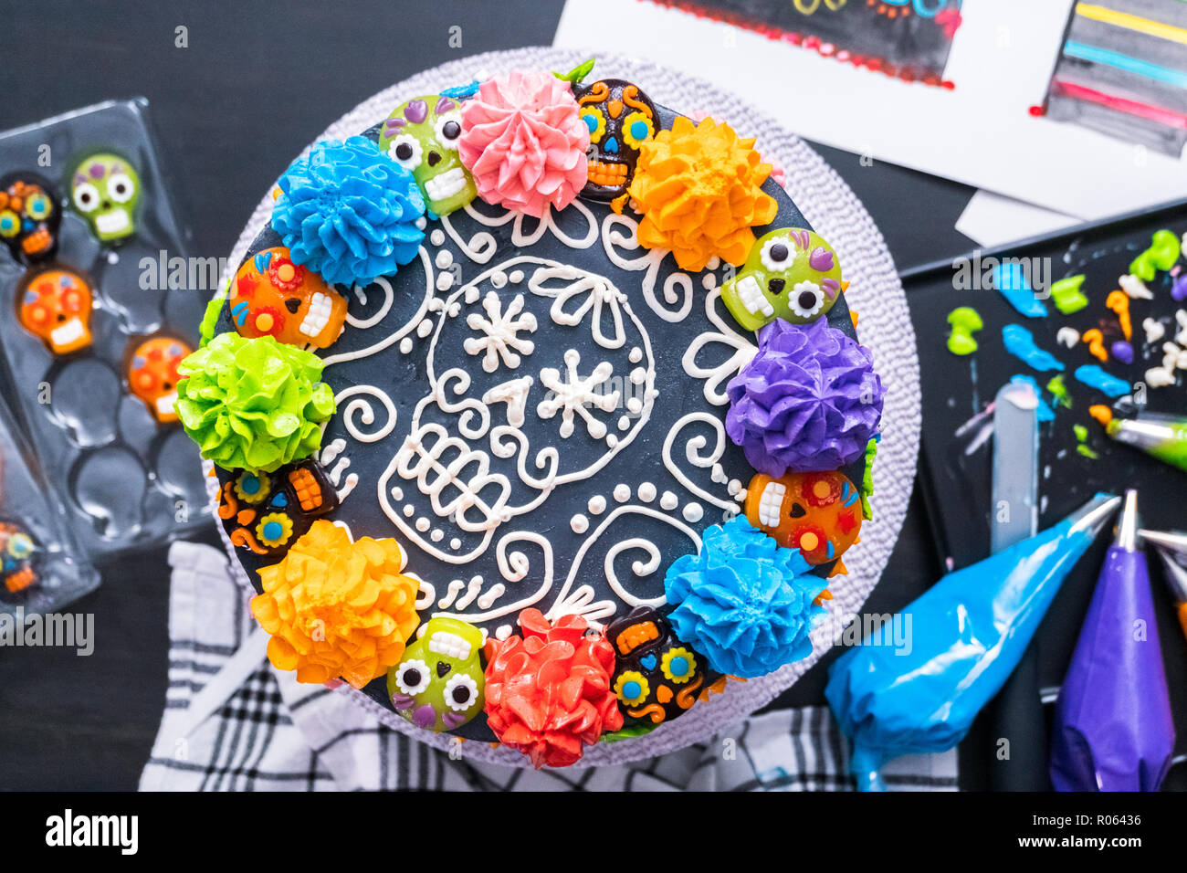 Flat lay. Gourmet Dia de los Muertos cake decorated with colorful ...
