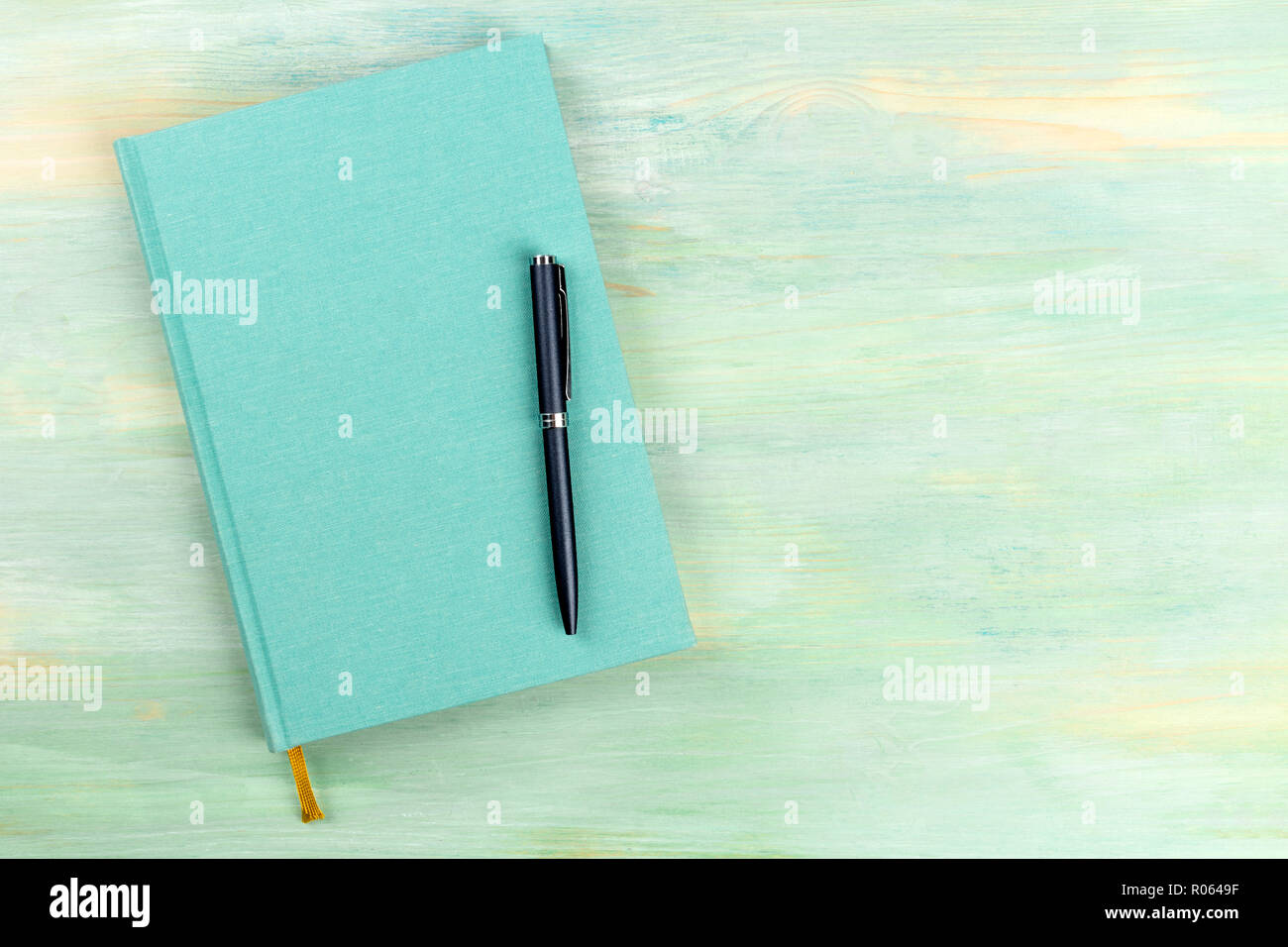 A photo of a blue journal with a pen, an elegant diary, notebook or ...