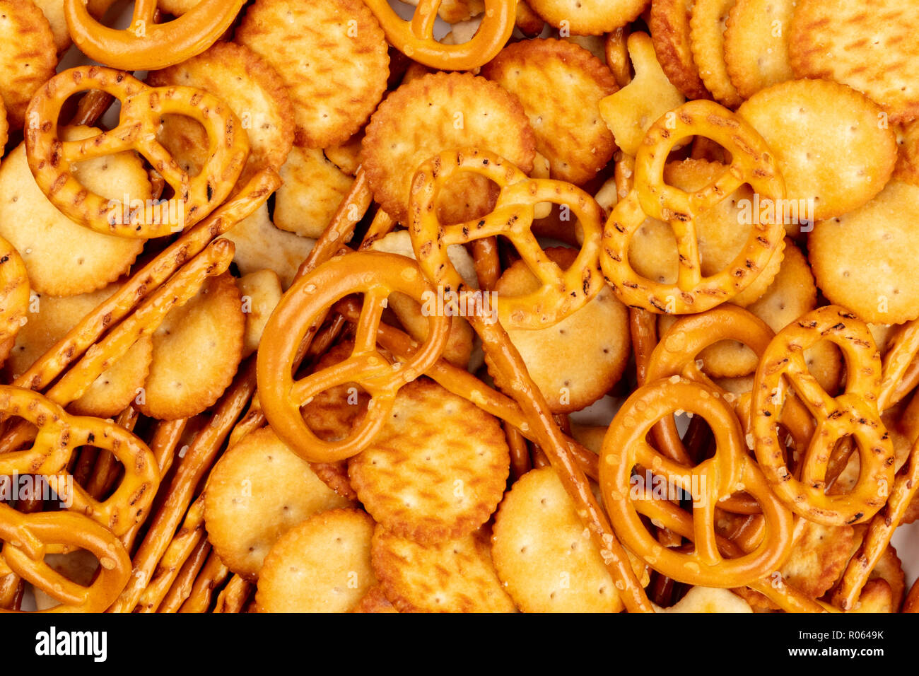 An overhead photo of many salt crackers, sticks, pretzels, and fishes ...
