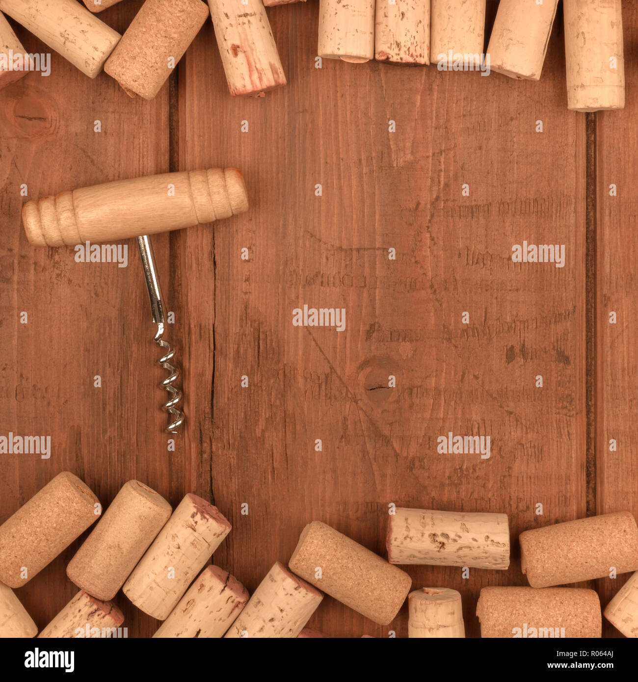 Many wine corks and a vintage corkscrew on a dark wooden background ...